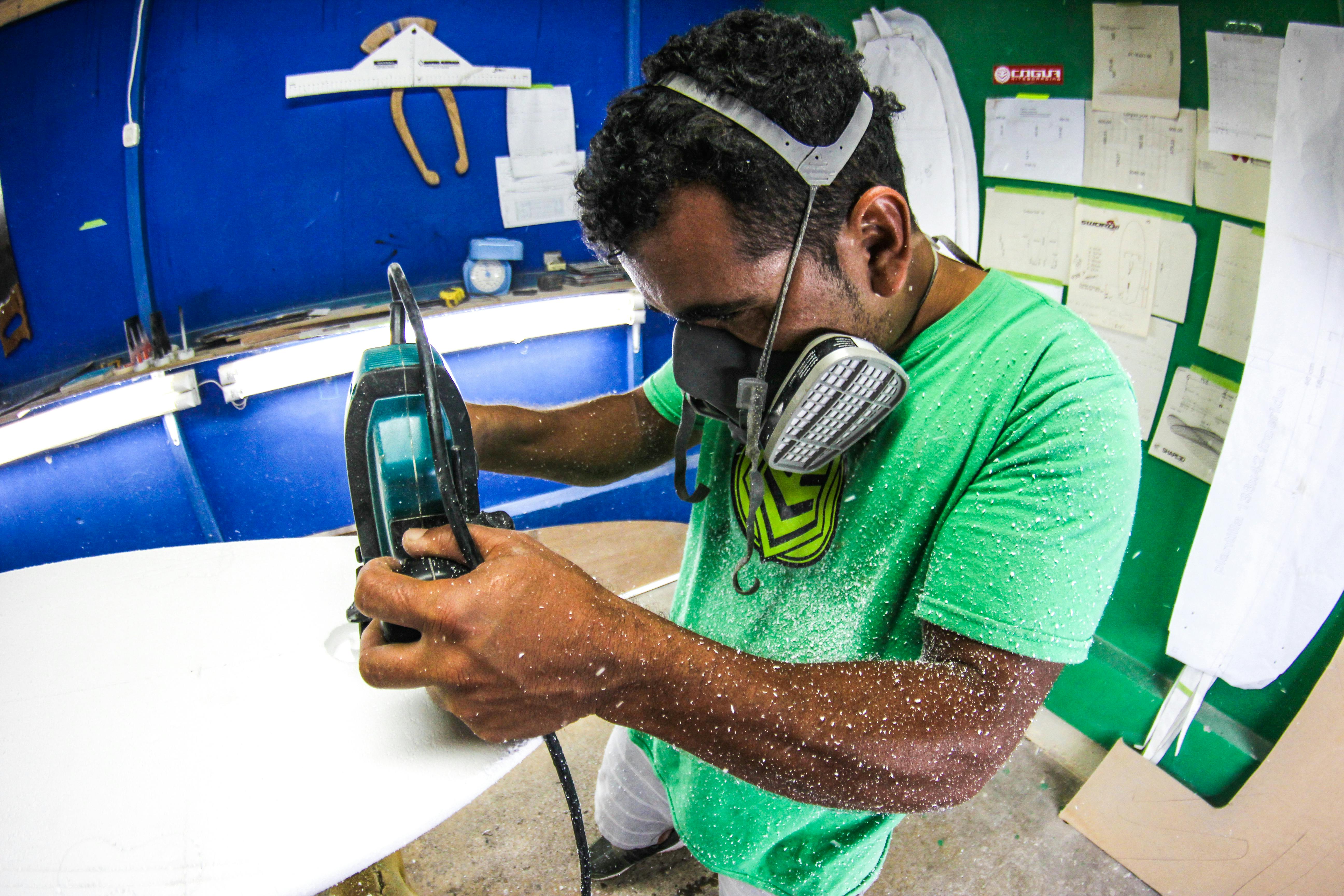 Man Using a Grinder in a Workshop · Free Stock Photo