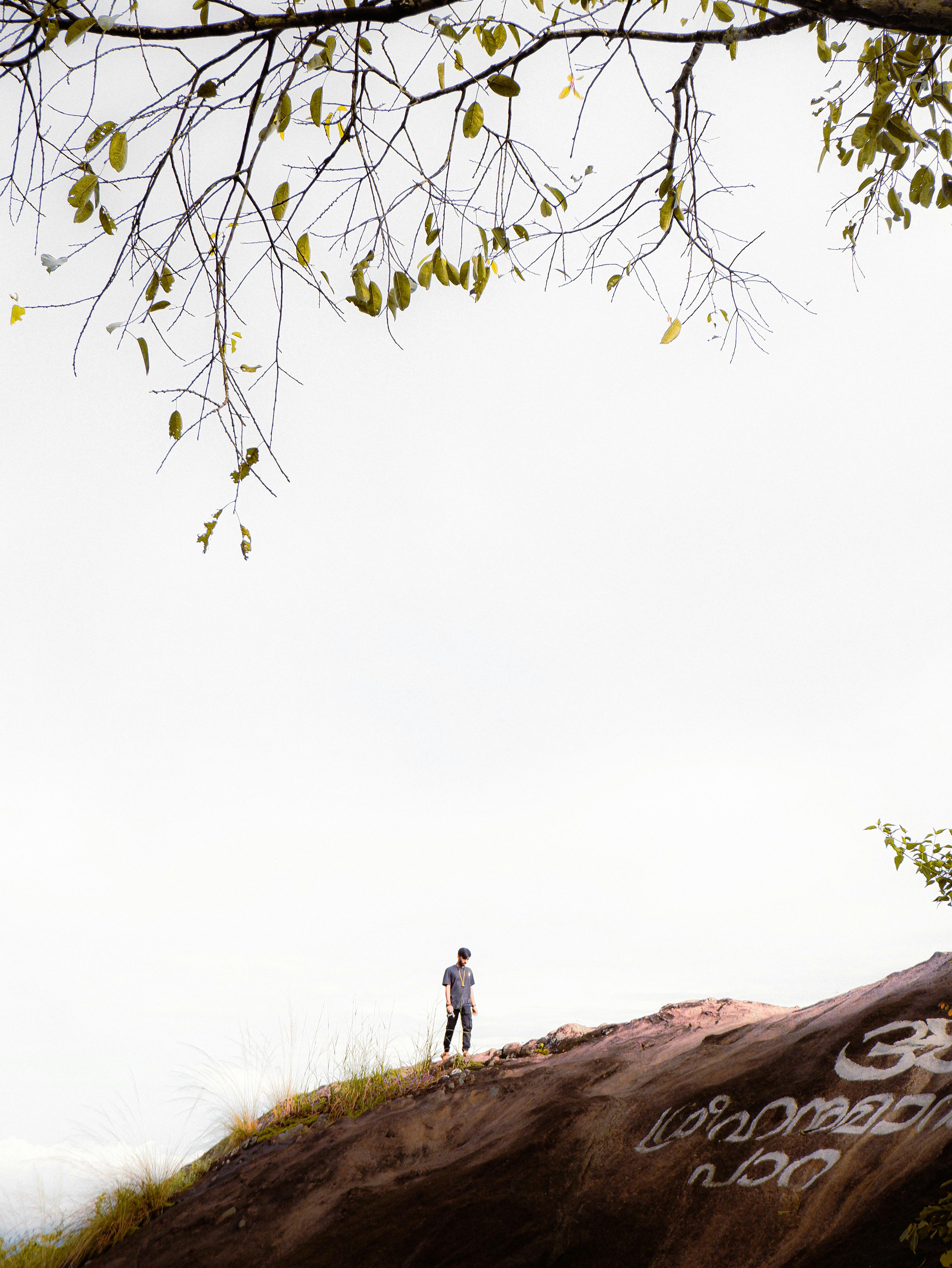 A Man in Black Jacket Walking inside Building · Free Stock Photo