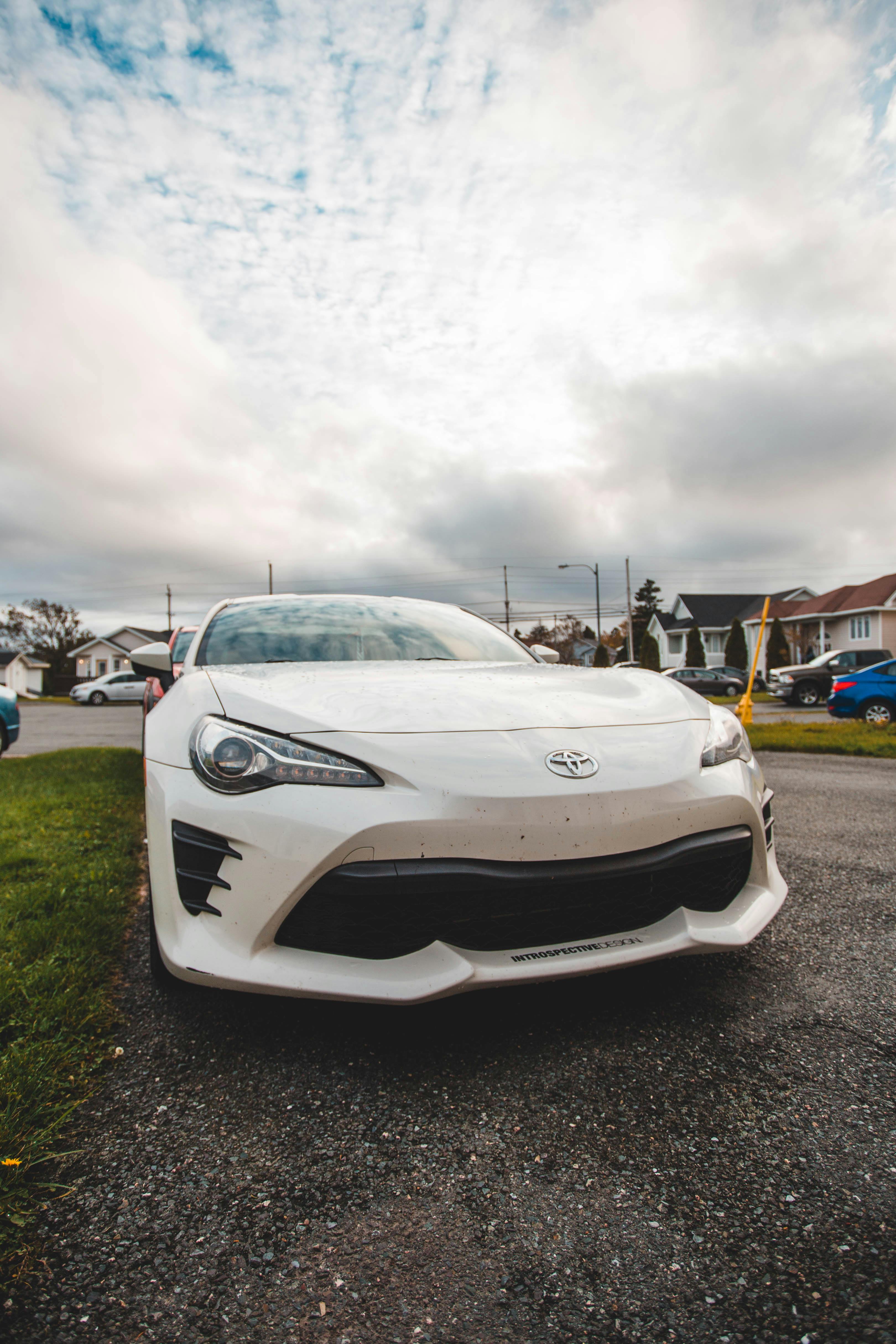 White Toyota Car Parked on the Road Under Cloudy Sky · Free Stock Photo