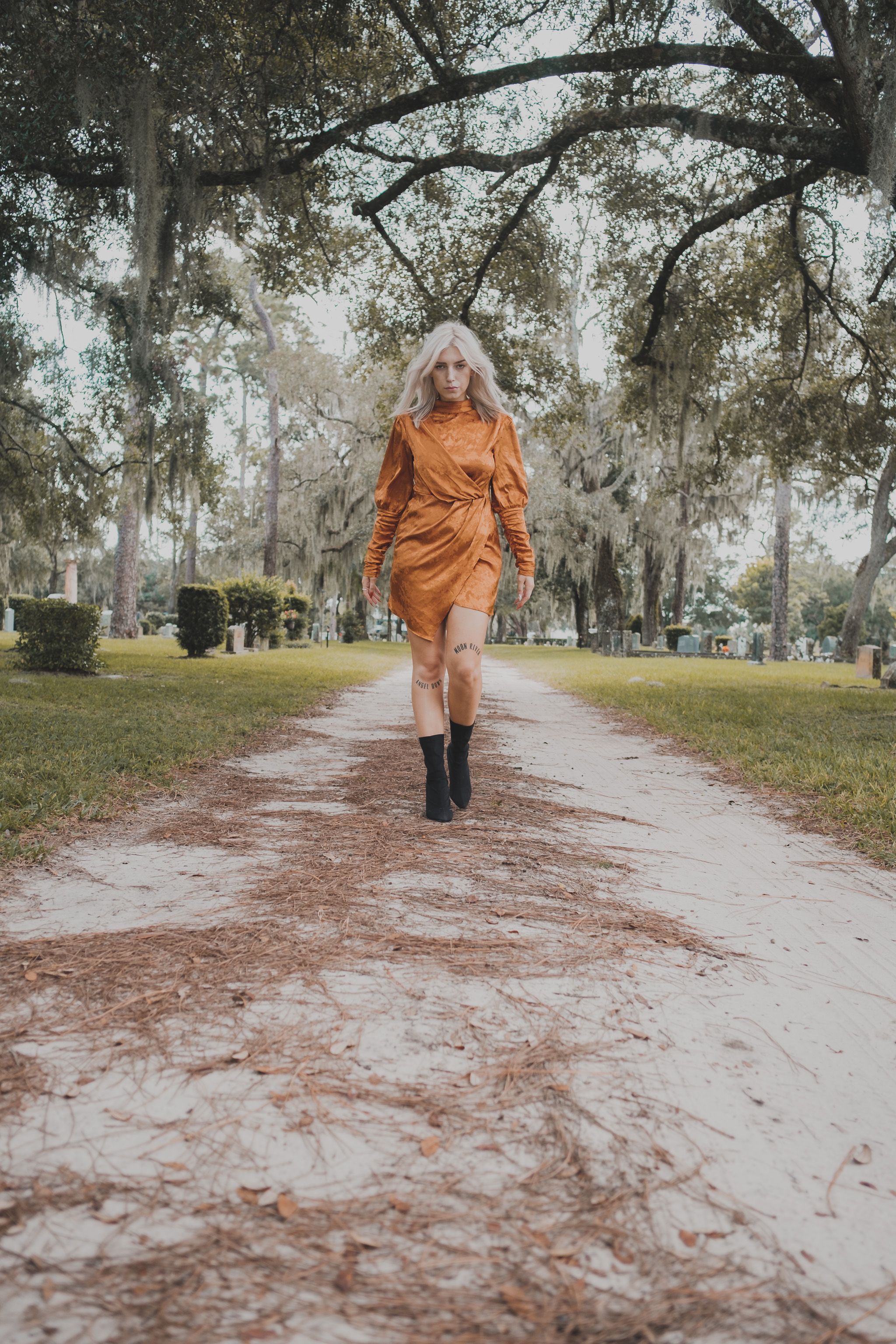 Photo of a Woman Standing with a Dog between her Legs · Free Stock Photo