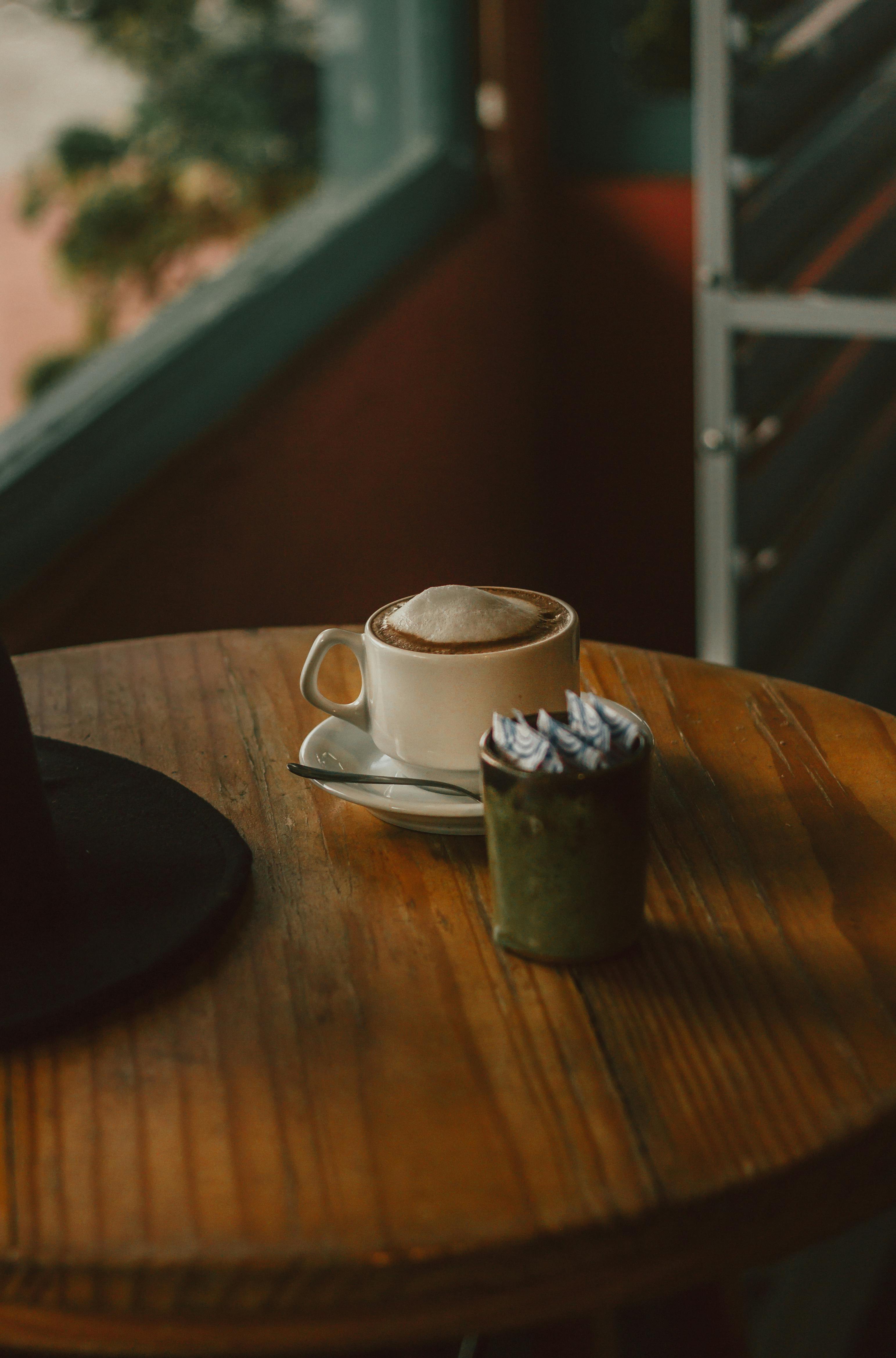 A Cup of Cofee Near a Pen, Paper, and Smartphone on a Table · Free ...