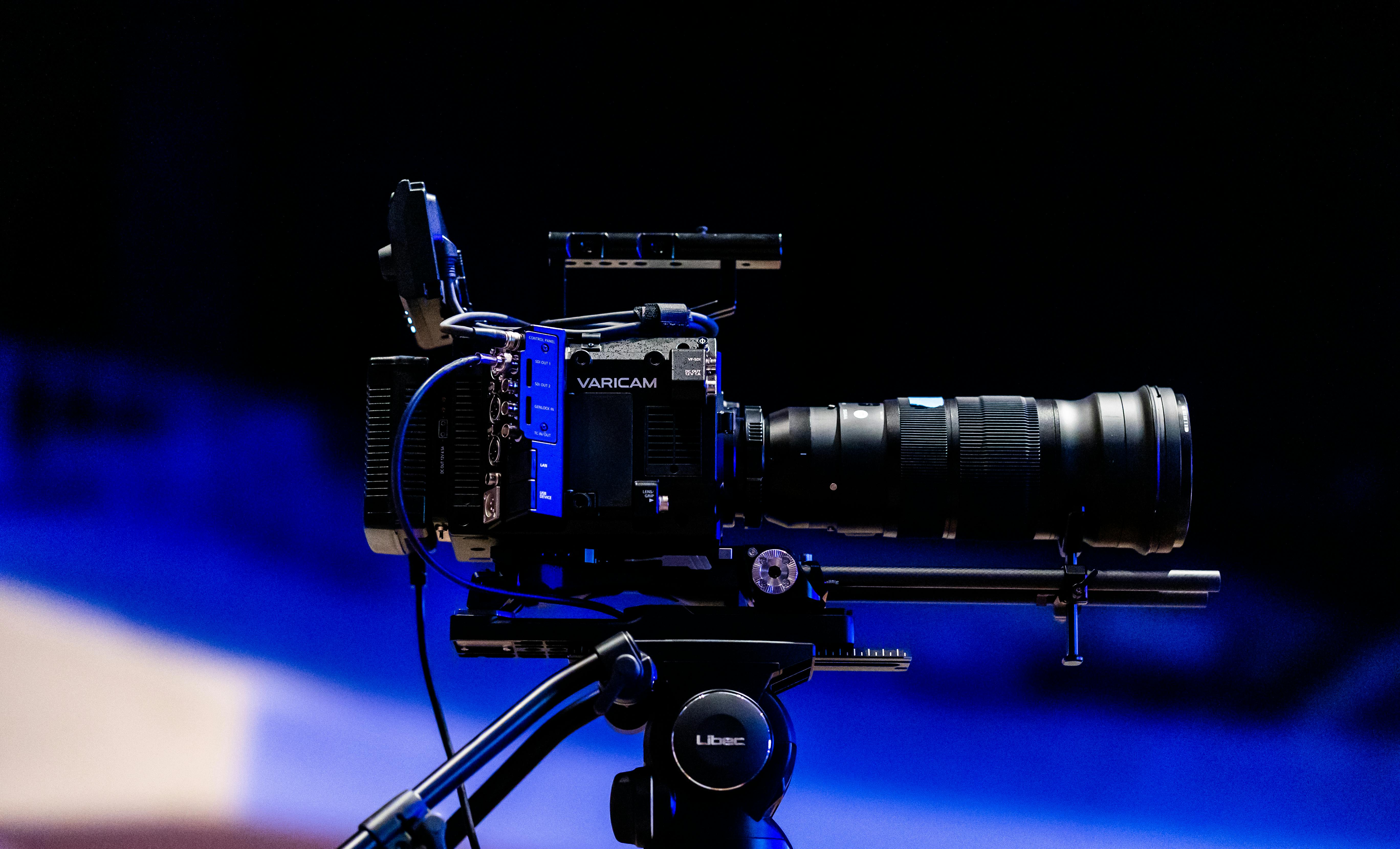 Photo of a Man Operating a Camera in a Studio · Free Stock Photo