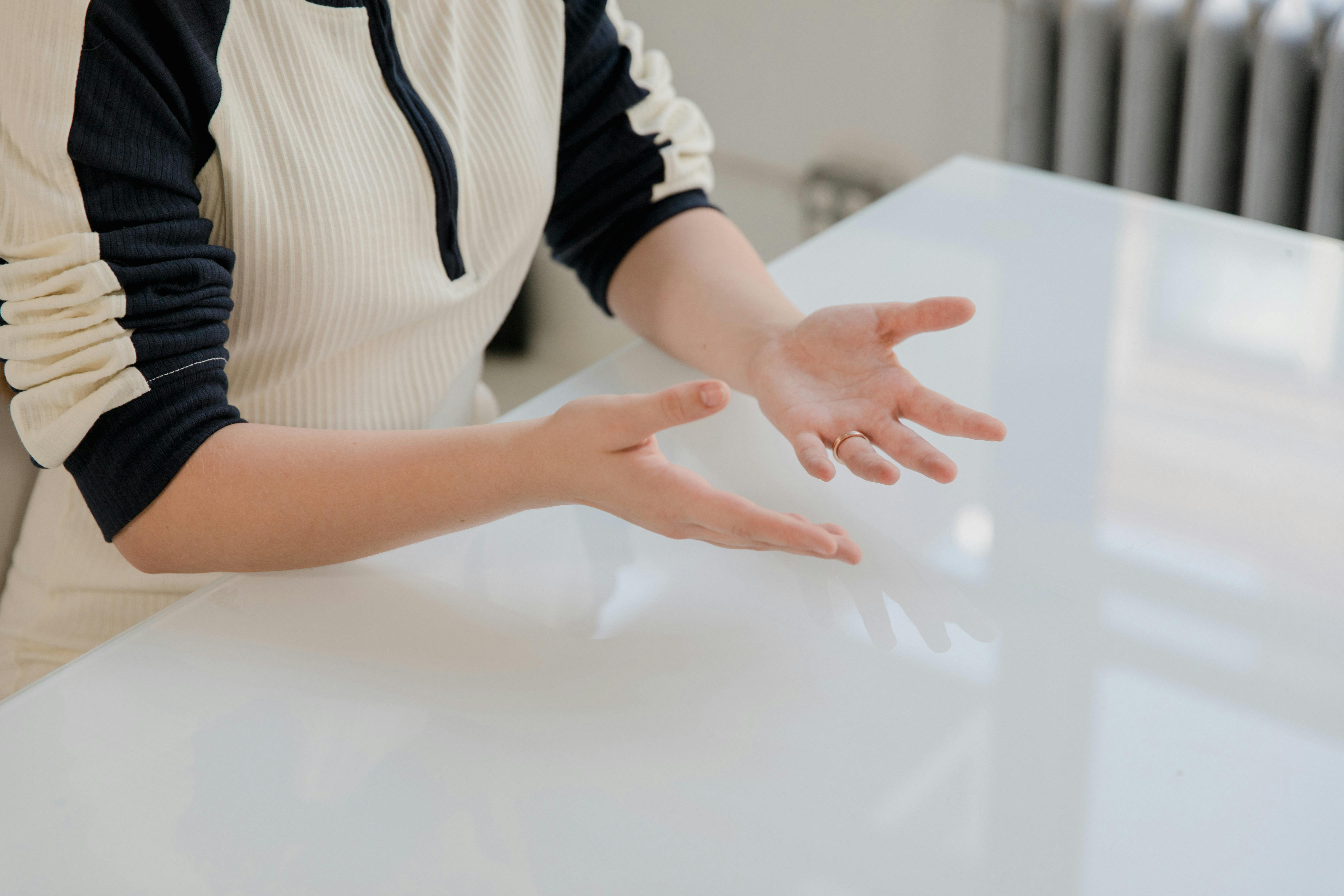 Photo Of People's Hand On Top Of Wooden Table · Free Stock Photo