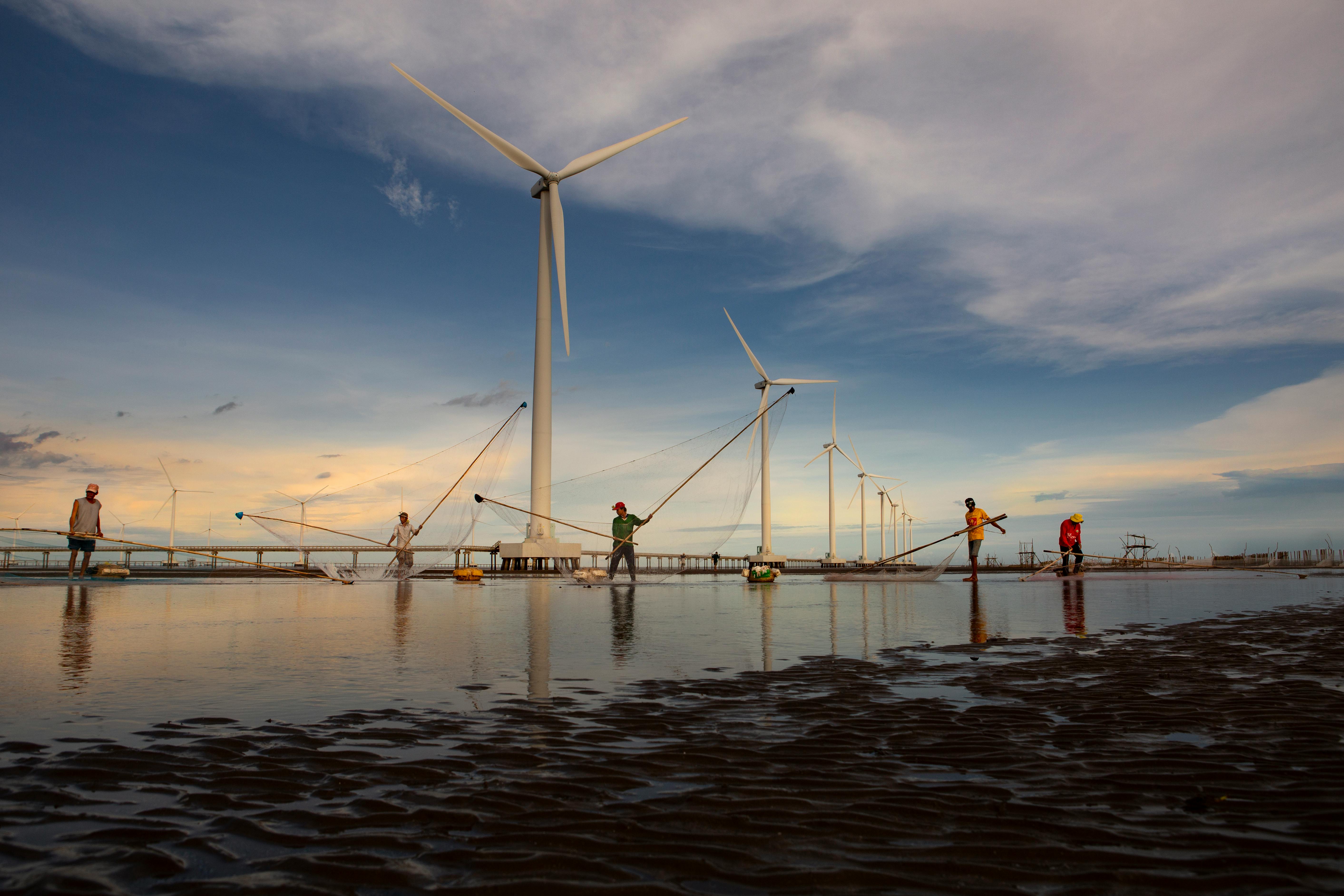 People Working near Wind Turbines · Free Stock Photo