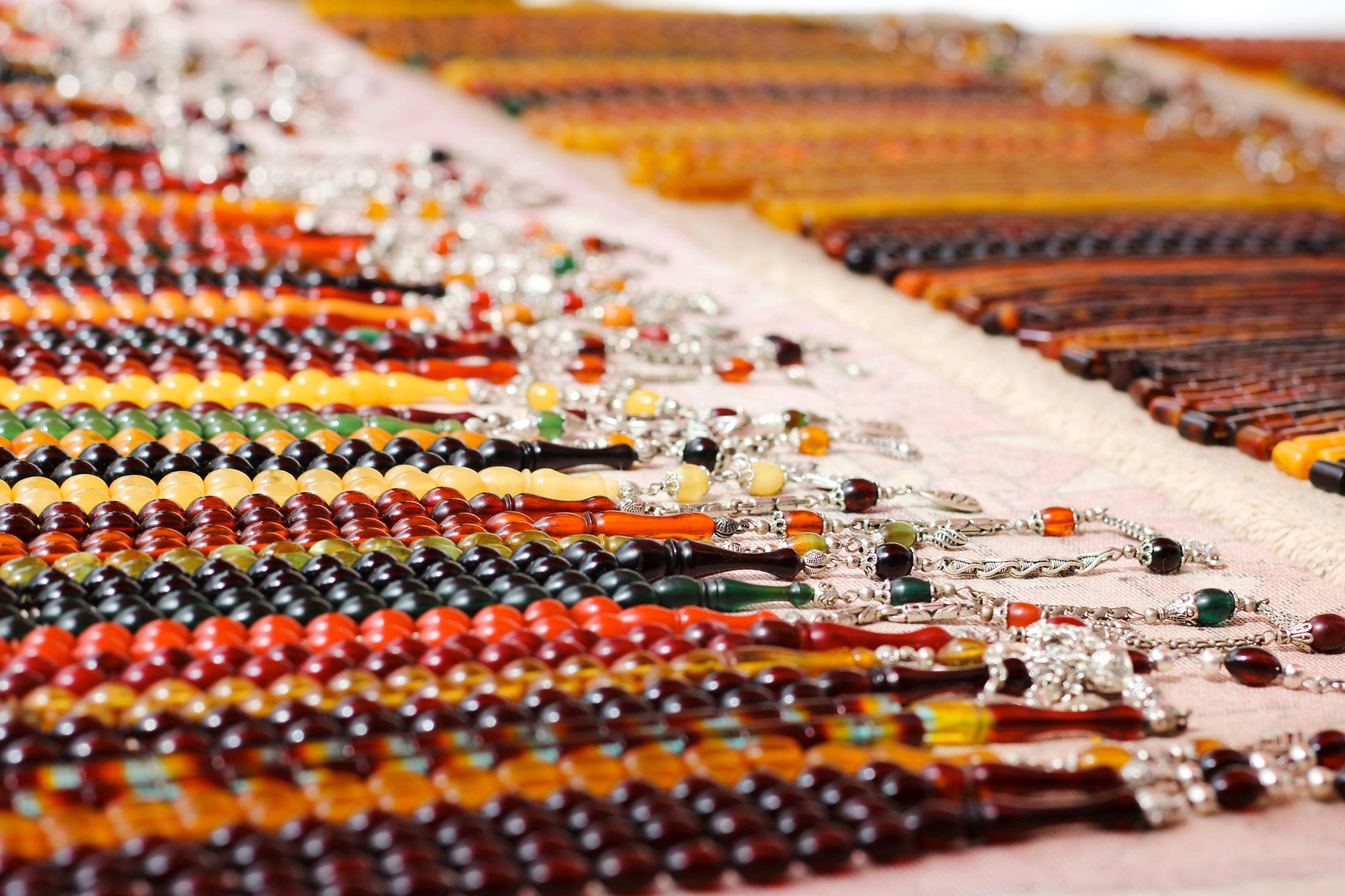 Close Up Photo of Beaded Accessories on Gray Surface · Free Stock Photo