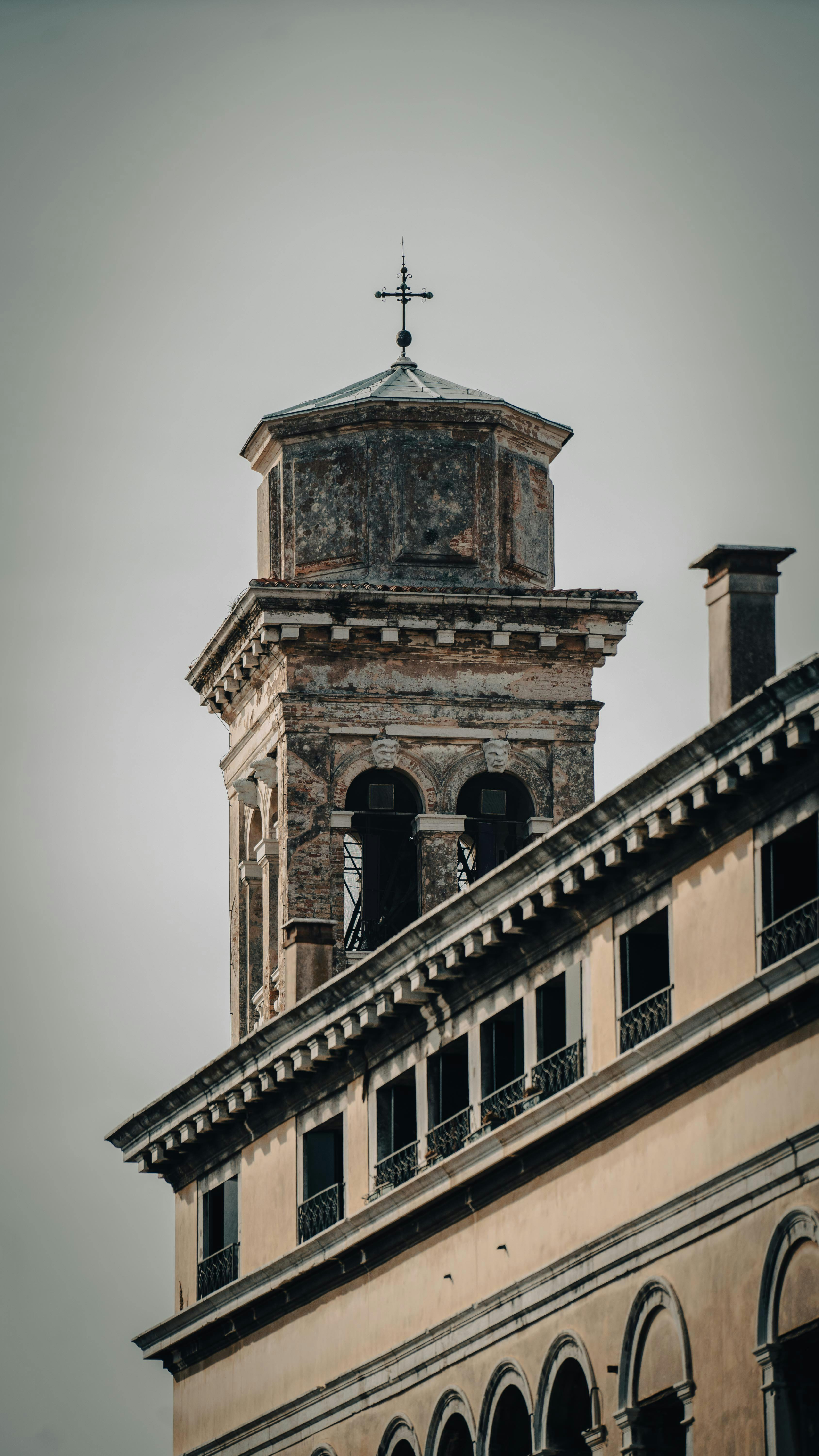 Gothic Church Tower over Rooftops · Free Stock Photo
