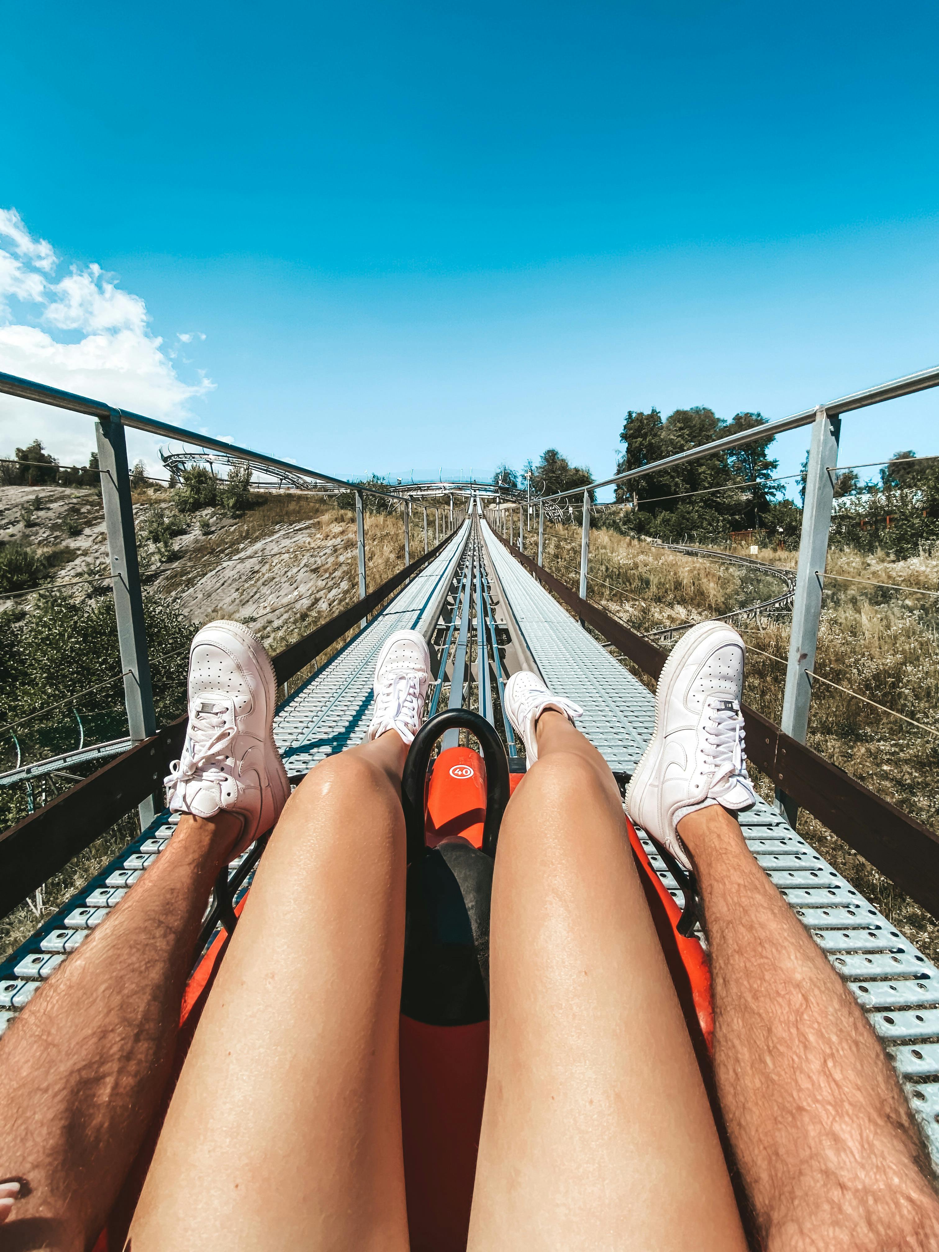 Two People Sliding on a Luge Track · Free Stock Photo