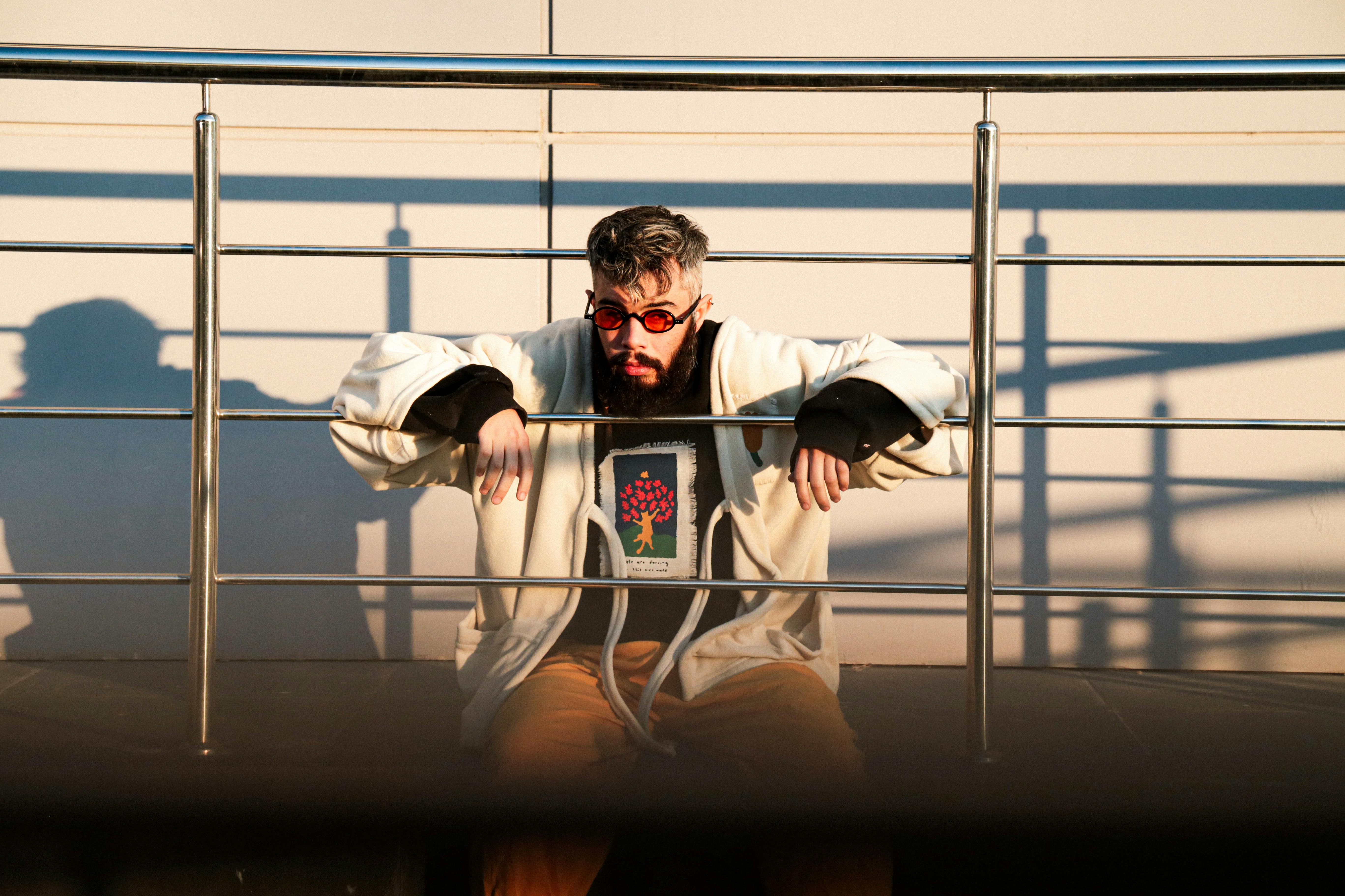 Man Posing on Balustrade · Free Stock Photo