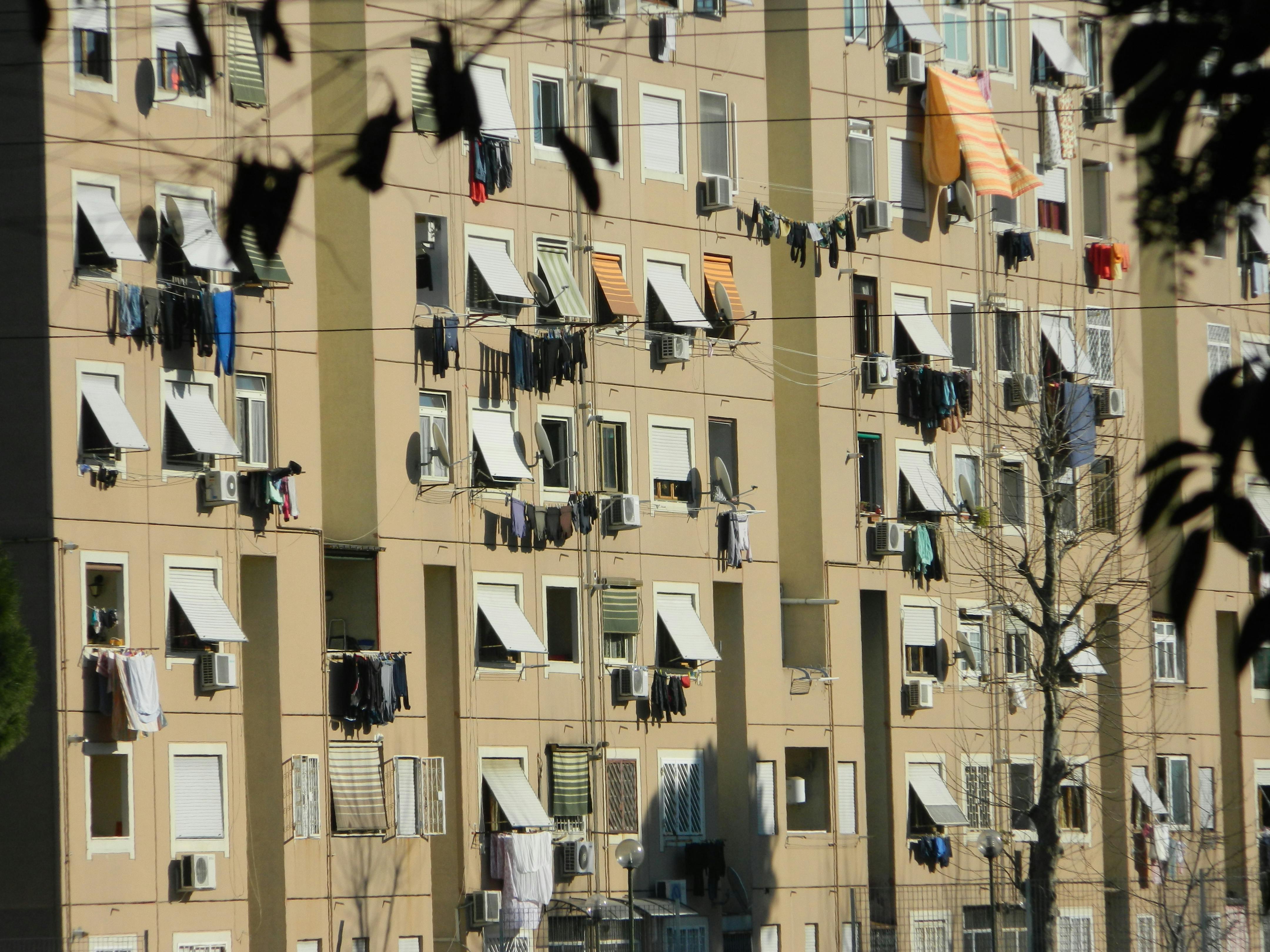Man By An Open Window With Assorted Clothing Hanging On Clotheslines ...