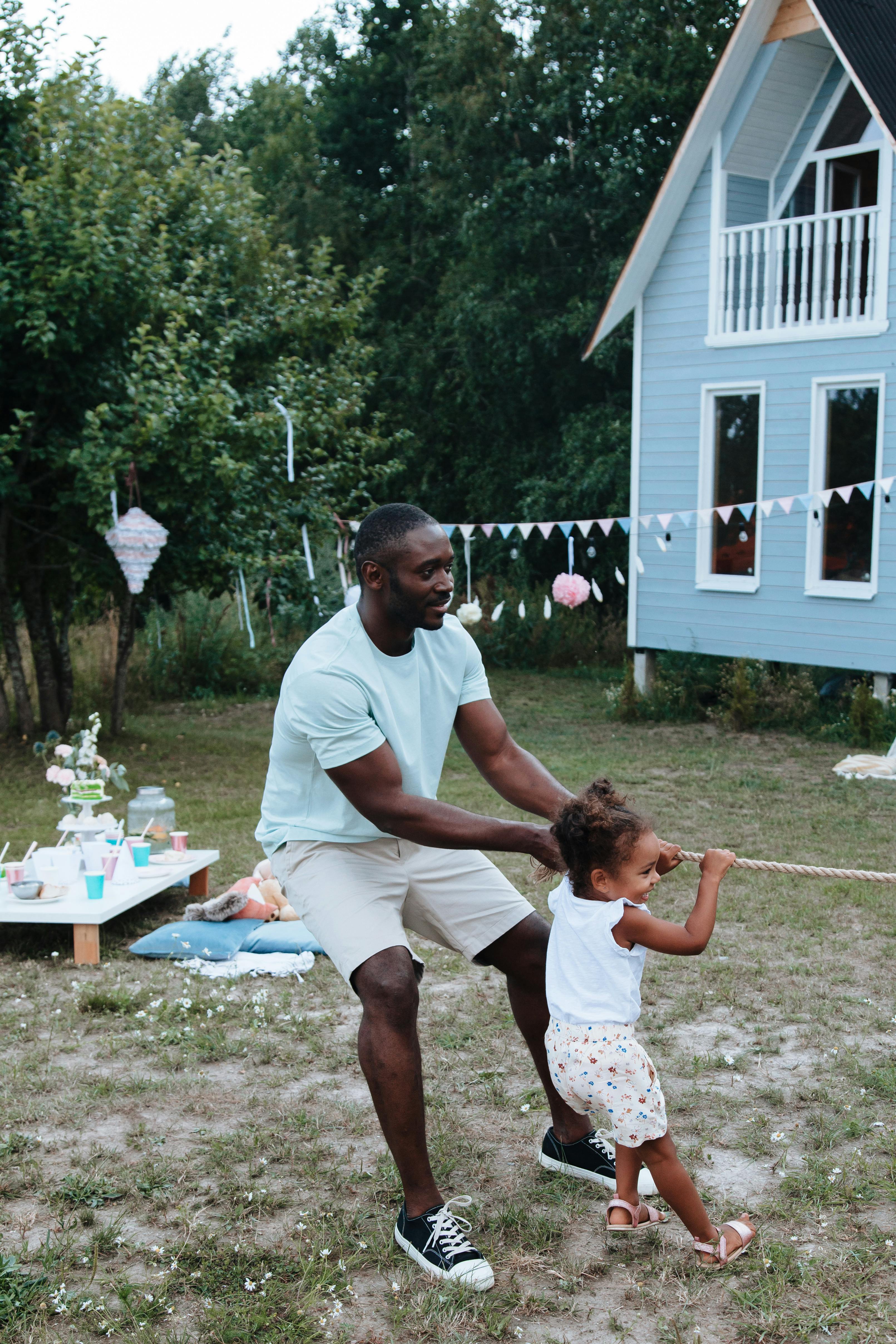 Father and Daughter Playing Tug of War · Free Stock Photo