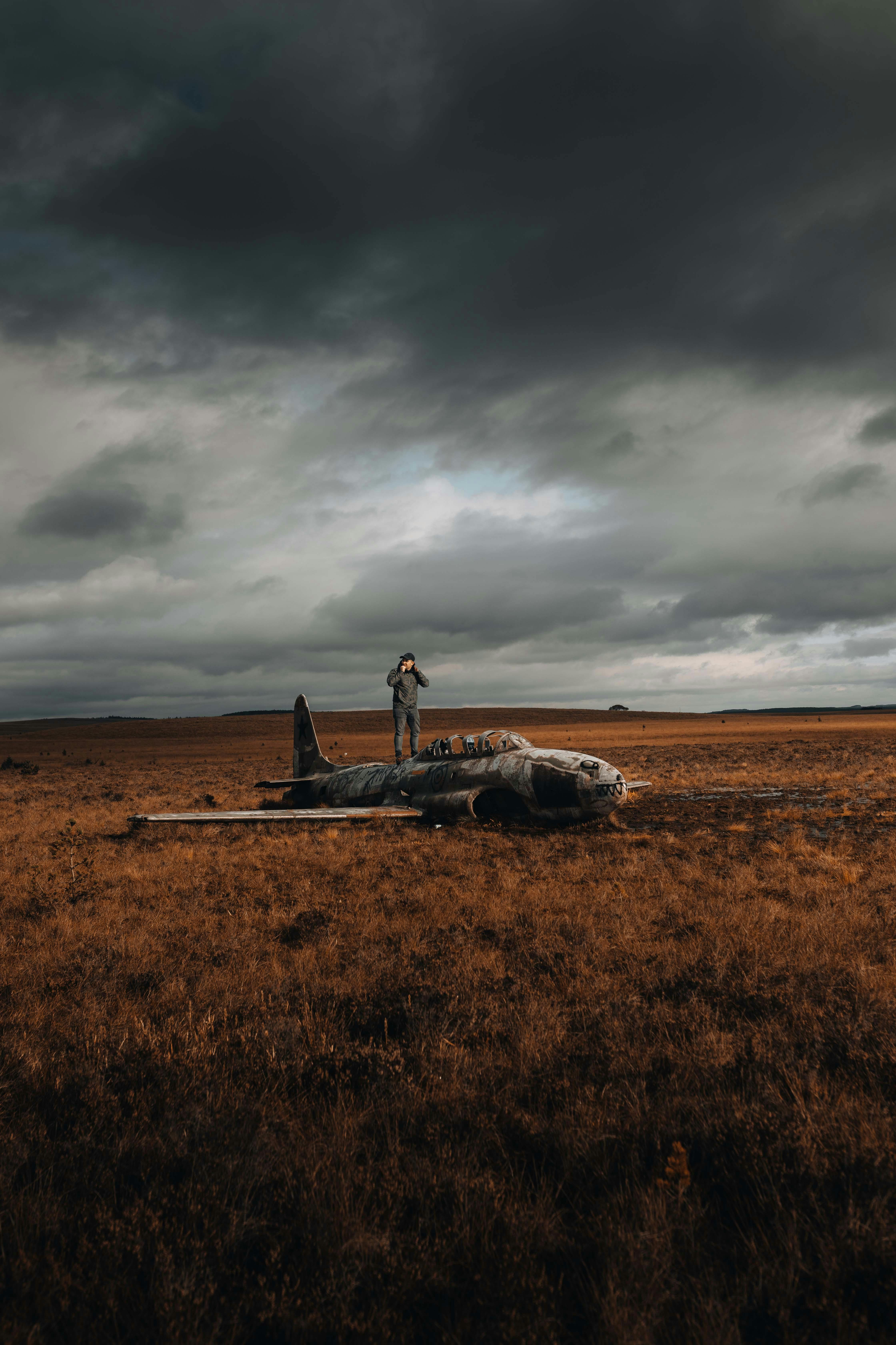 Pilot Standing on Small Airplane Fuselage Laying in Middle of Autumn ...
