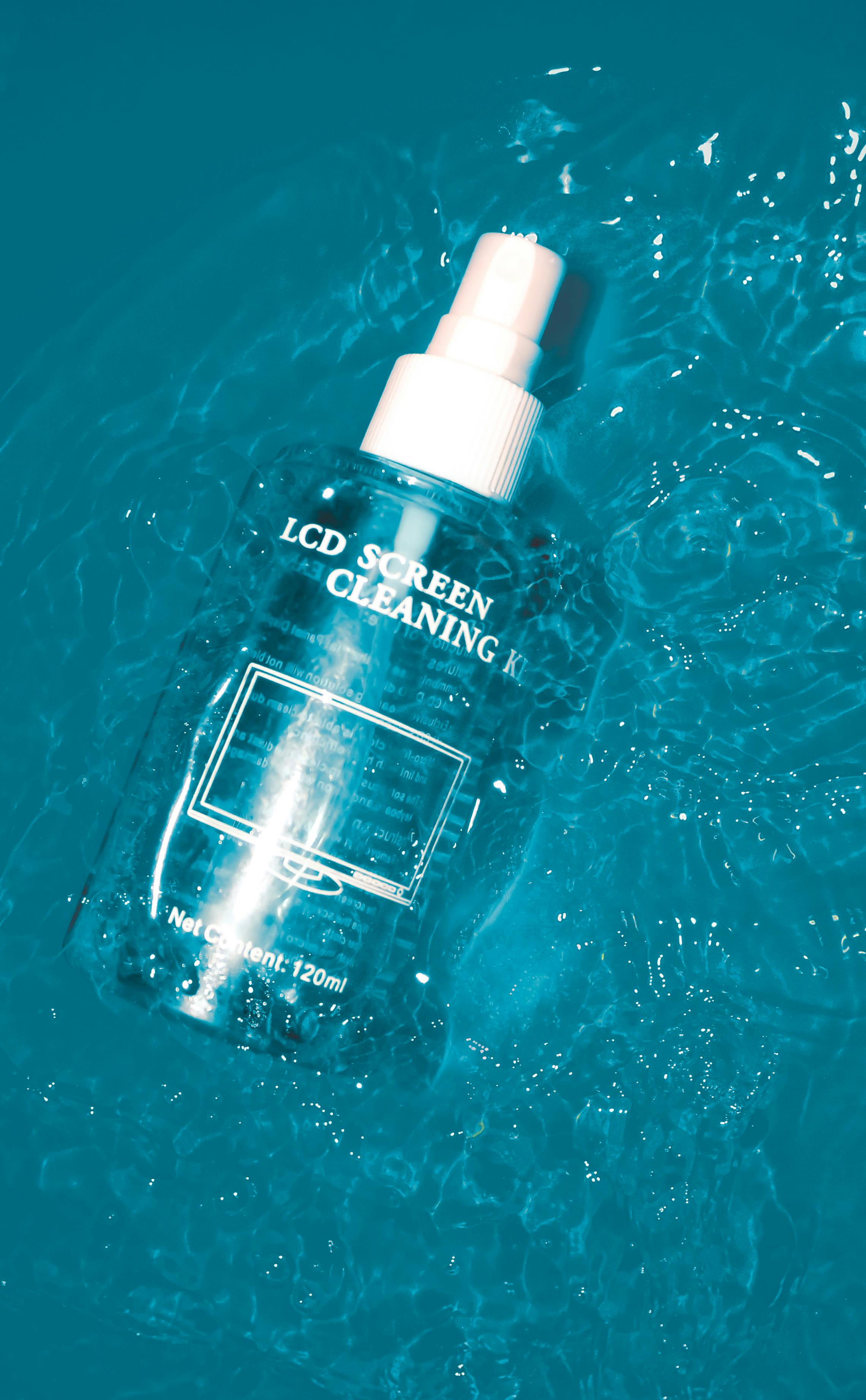 Close-Up Shot of a Spray Bottle on the Water · Free Stock Photo