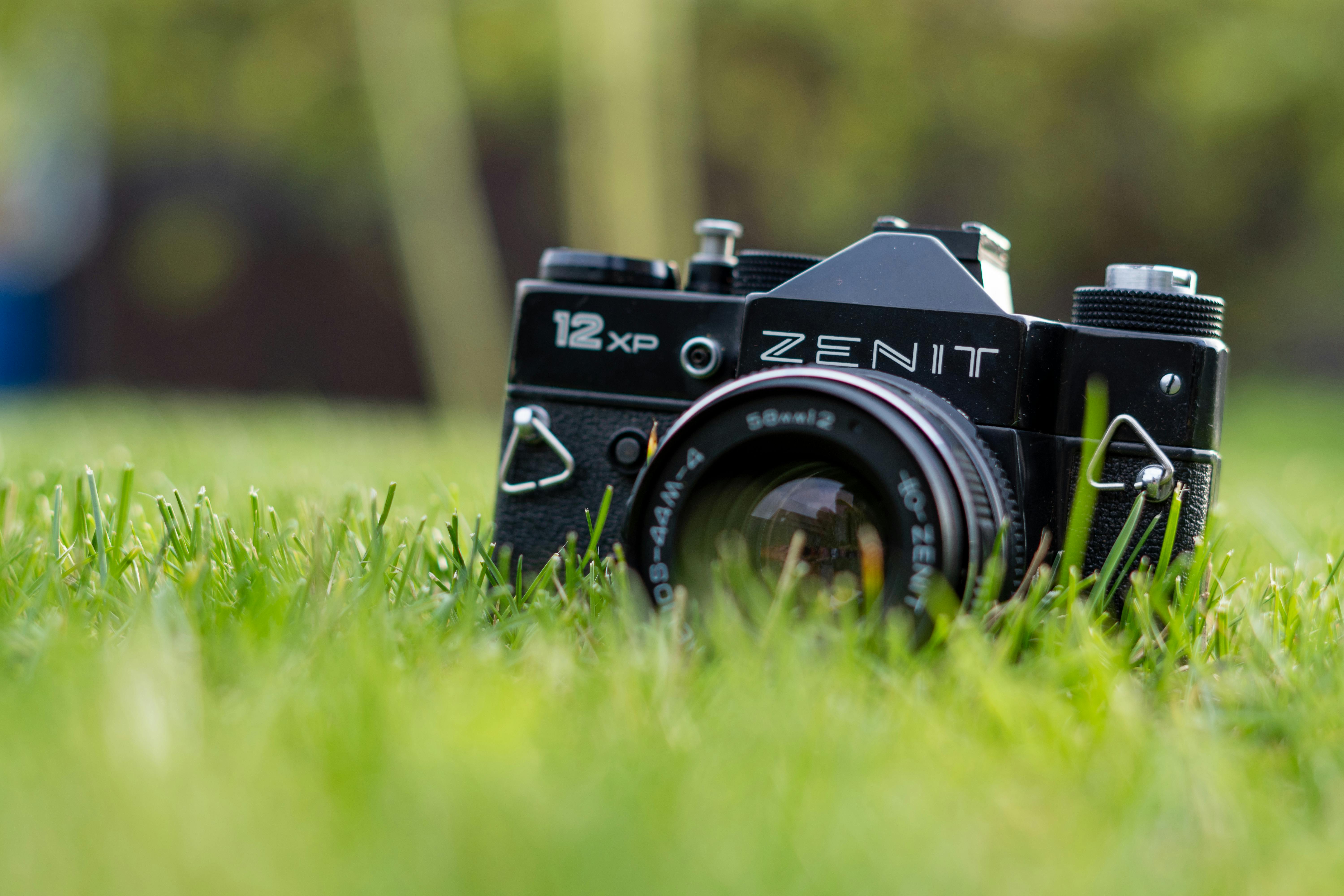 Close-Up Photograph of a Black Camera on the Grass · Free Stock Photo
