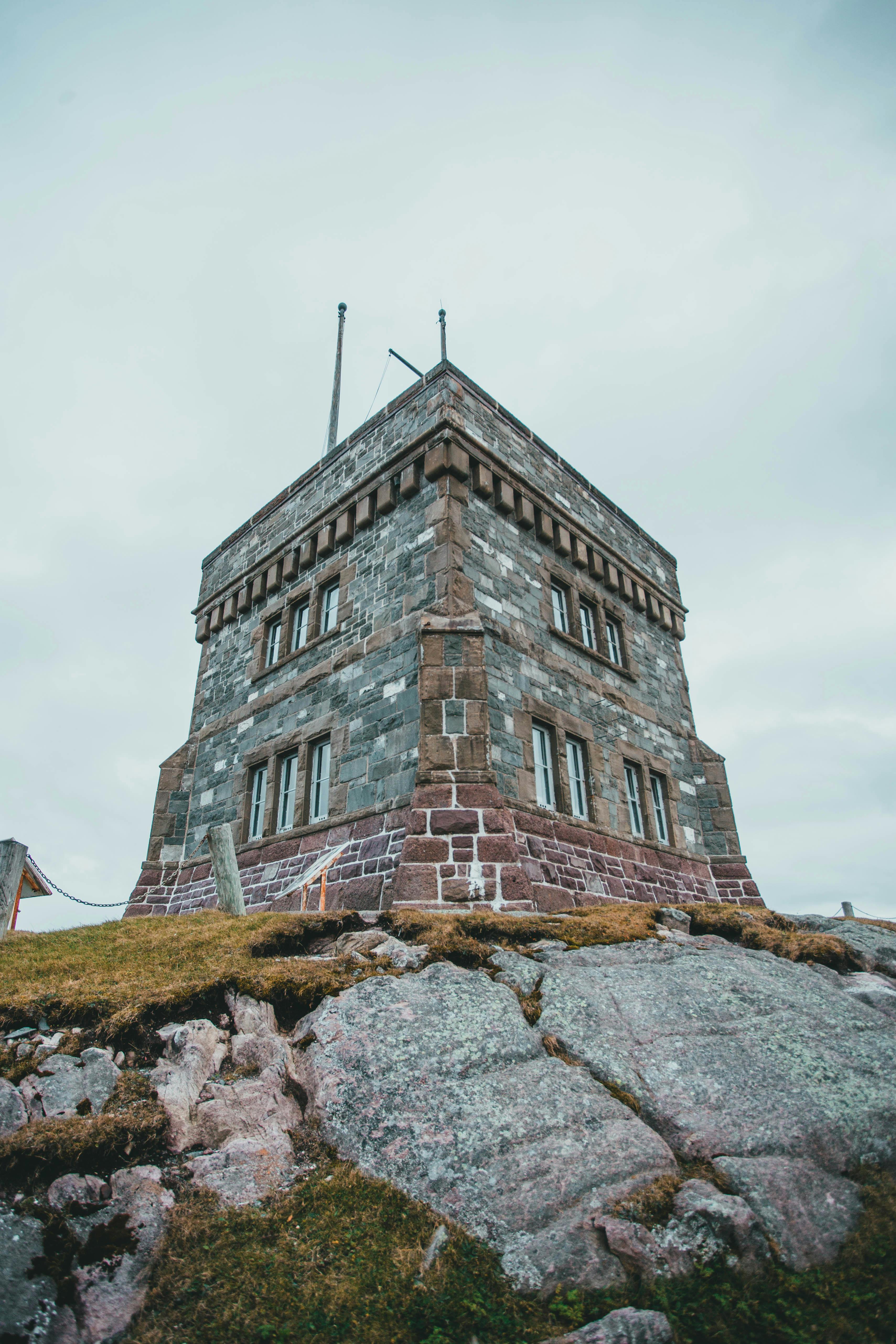 Historic tower on hill slope under sunset sky · Free Stock Photo