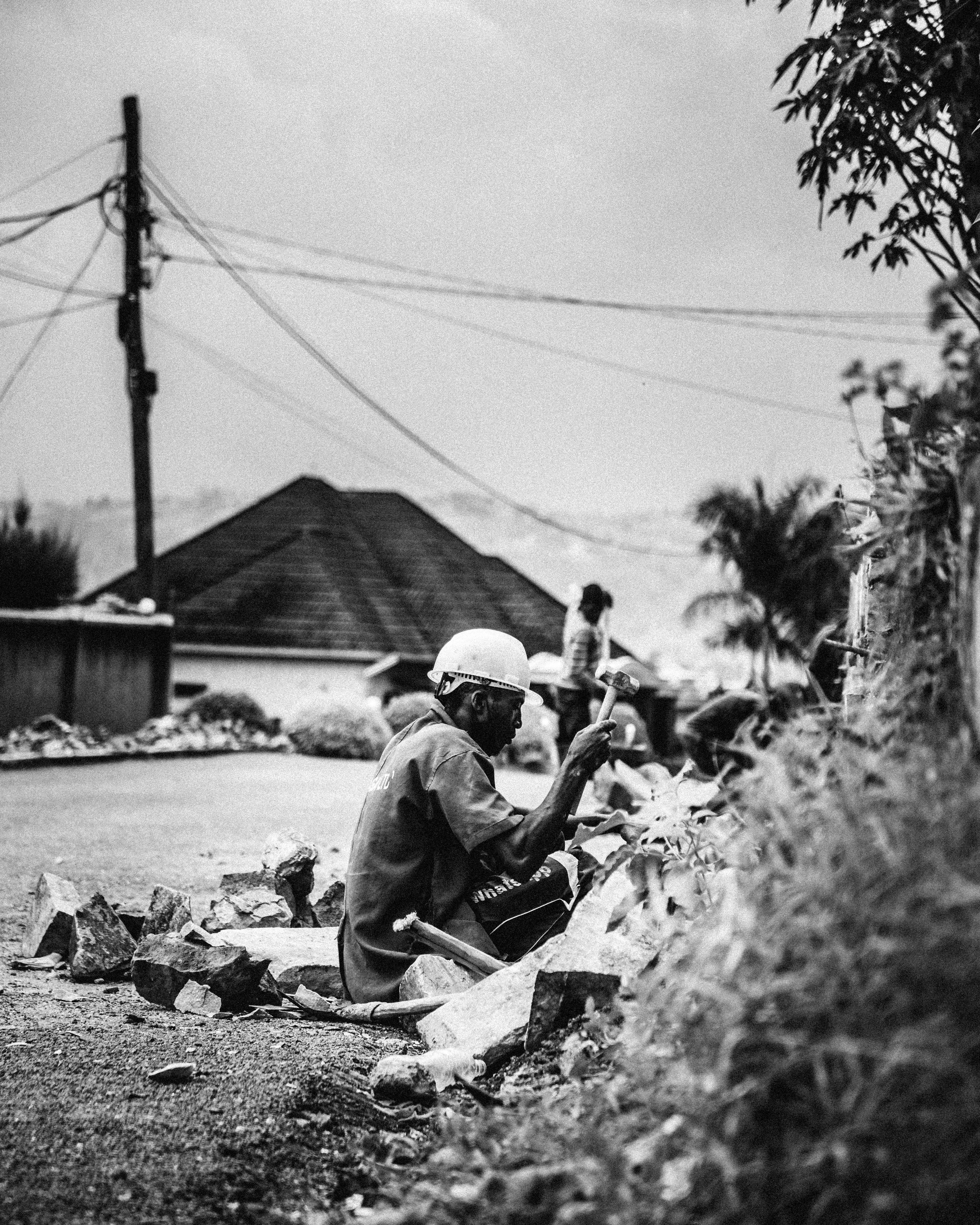 Grayscale Photo of a Man Holding a Hammer · Free Stock Photo