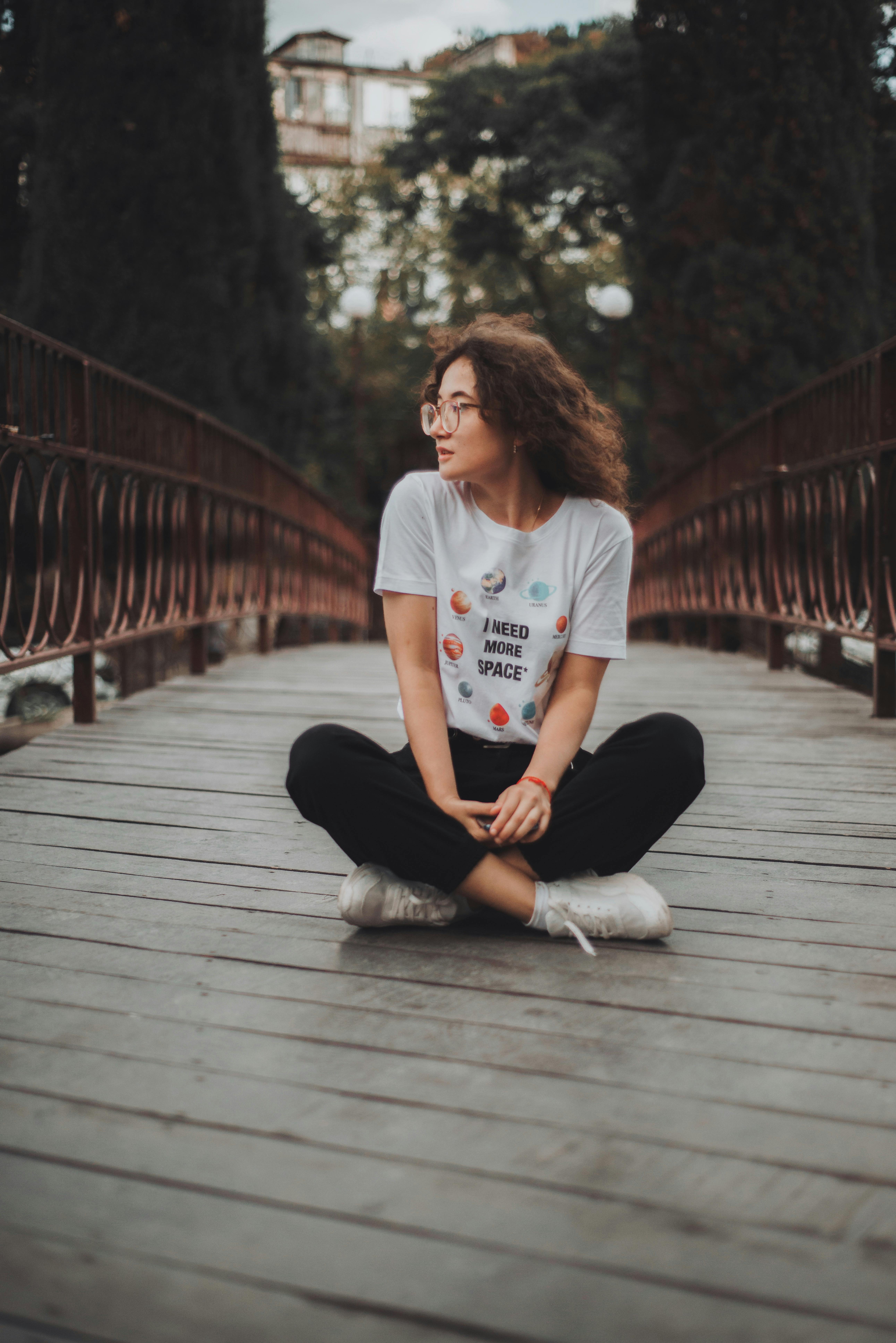 A Woman Sitting on the Bridge · Free Stock Photo