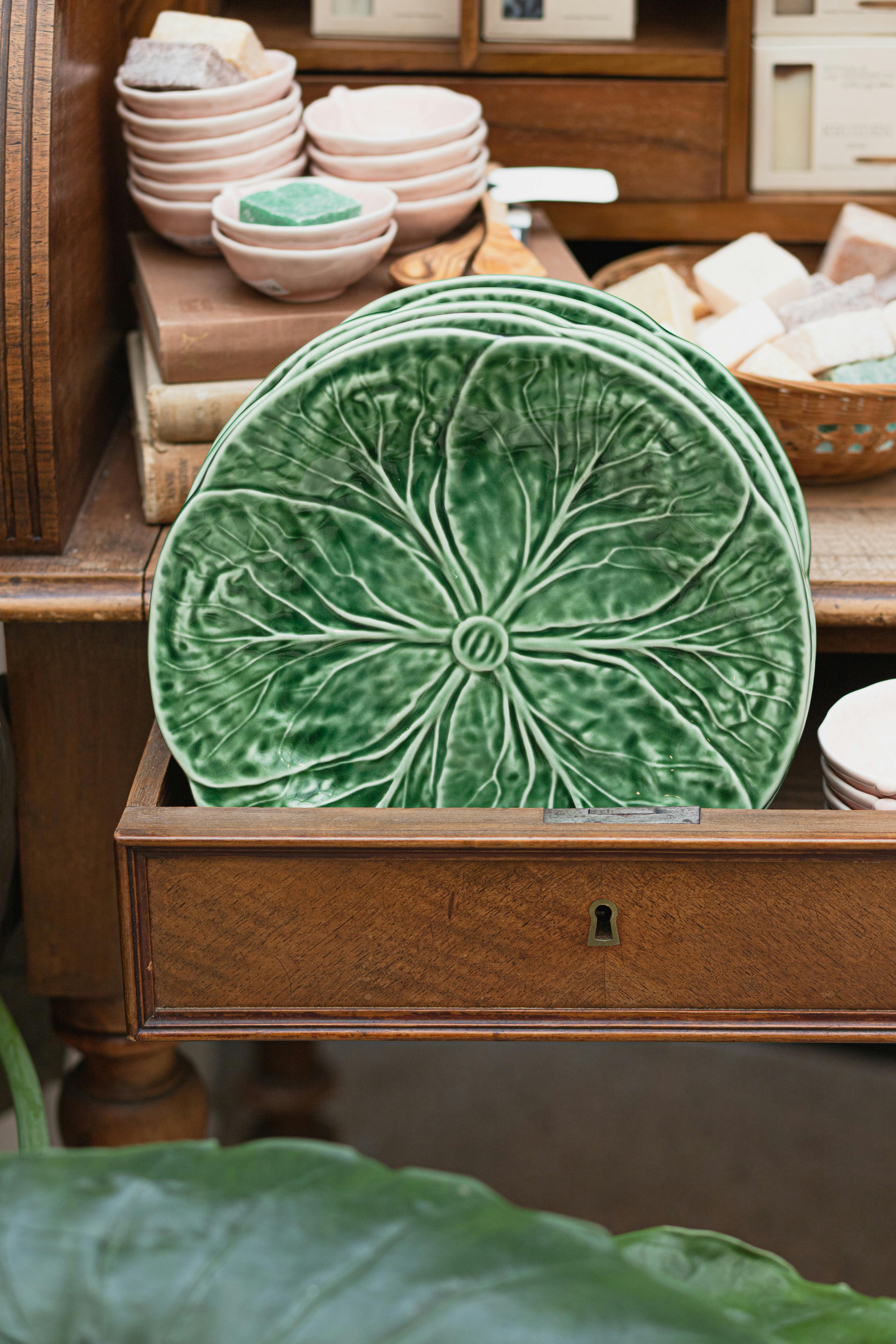 Green Ceramic Plates on a Drawer · Free Stock Photo