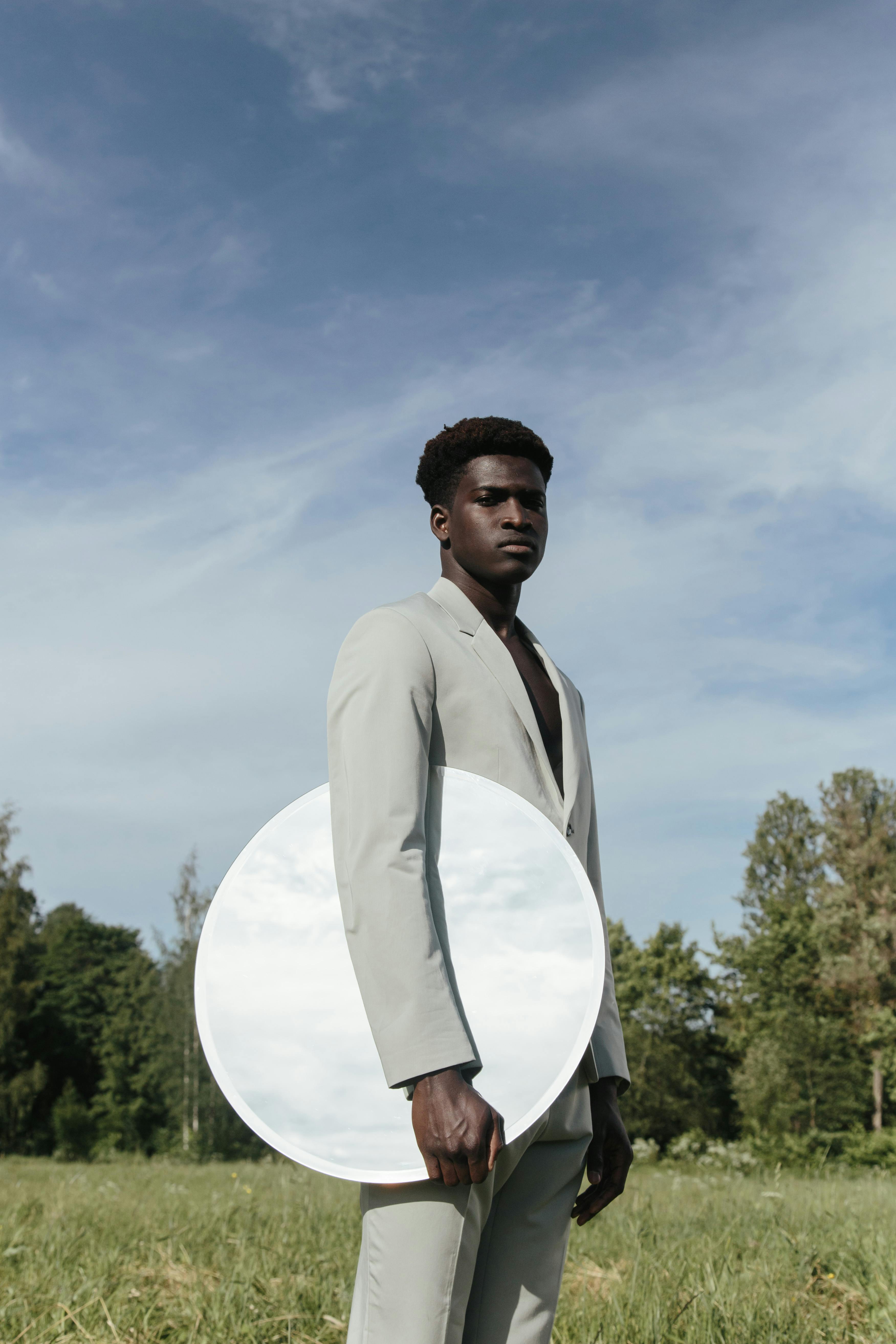 Man Holding Yellow Plate in a Studio · Free Stock Photo