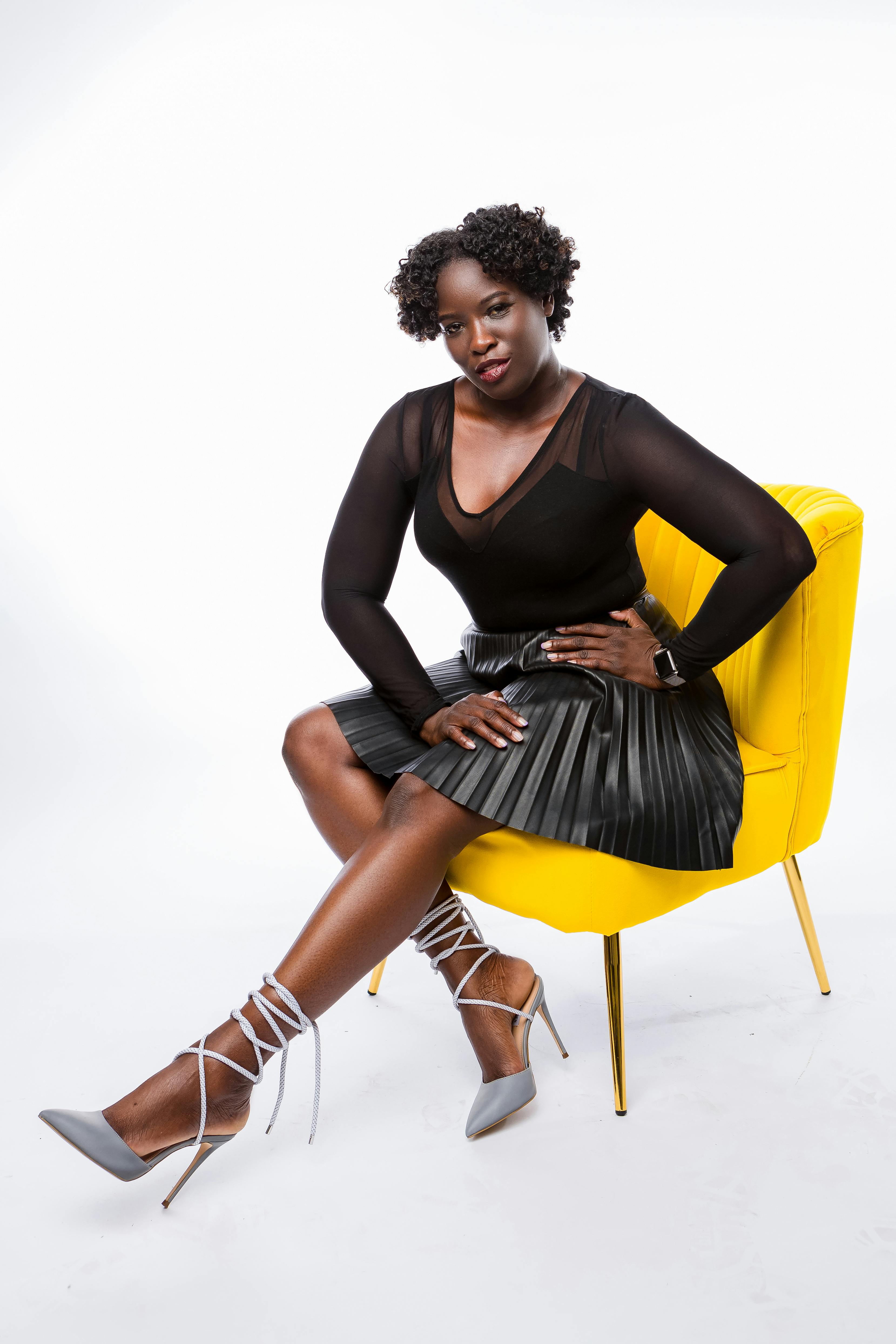 Woman Sitting on Yellow Chair · Free Stock Photo