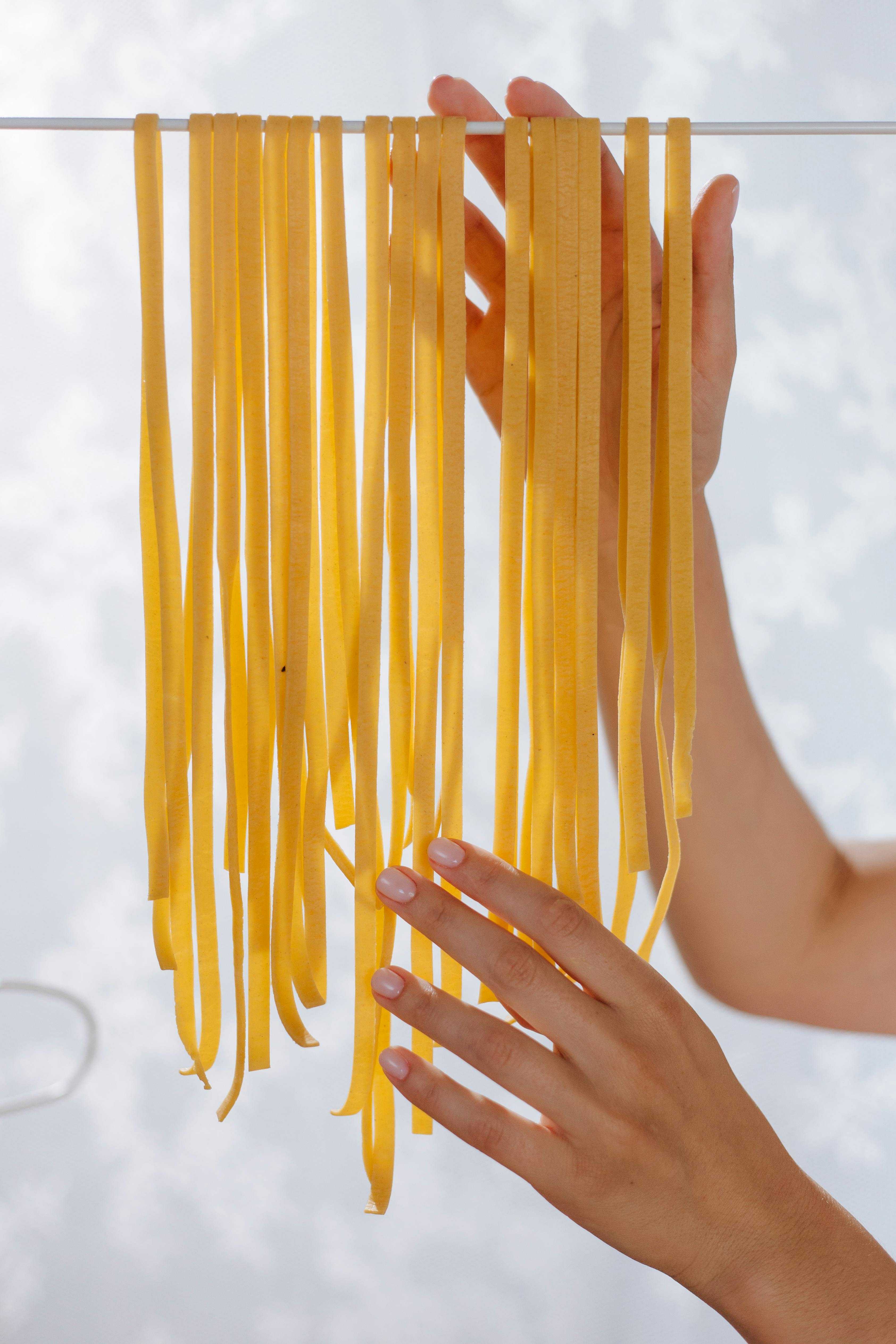 A Profile View of a Female Eating a Pasta · Free Stock Photo