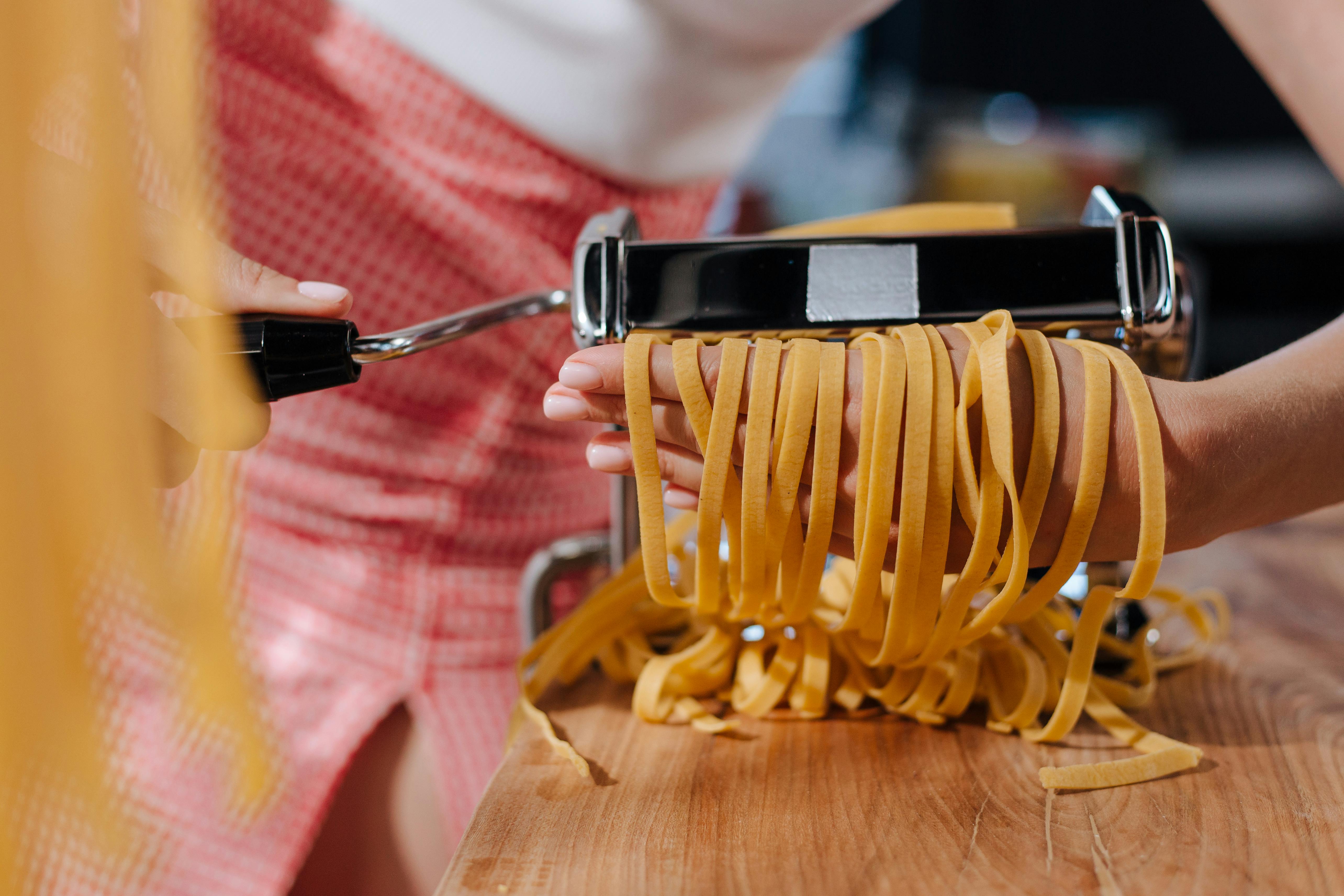 A Female Hands Using Pasta Maker · Free Stock Photo
