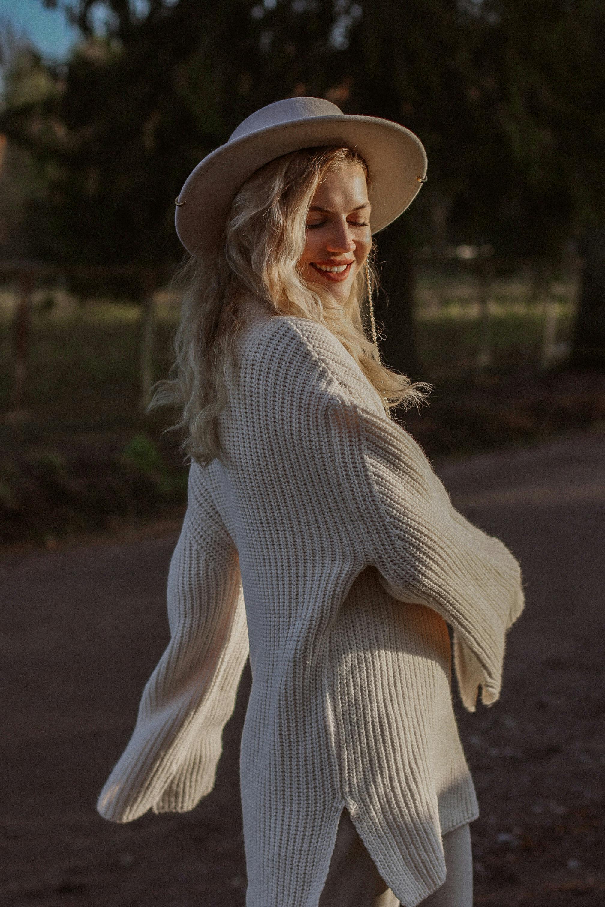 Person Wearing White Fedora Hat Holding Carnation Flowers · Free Stock ...