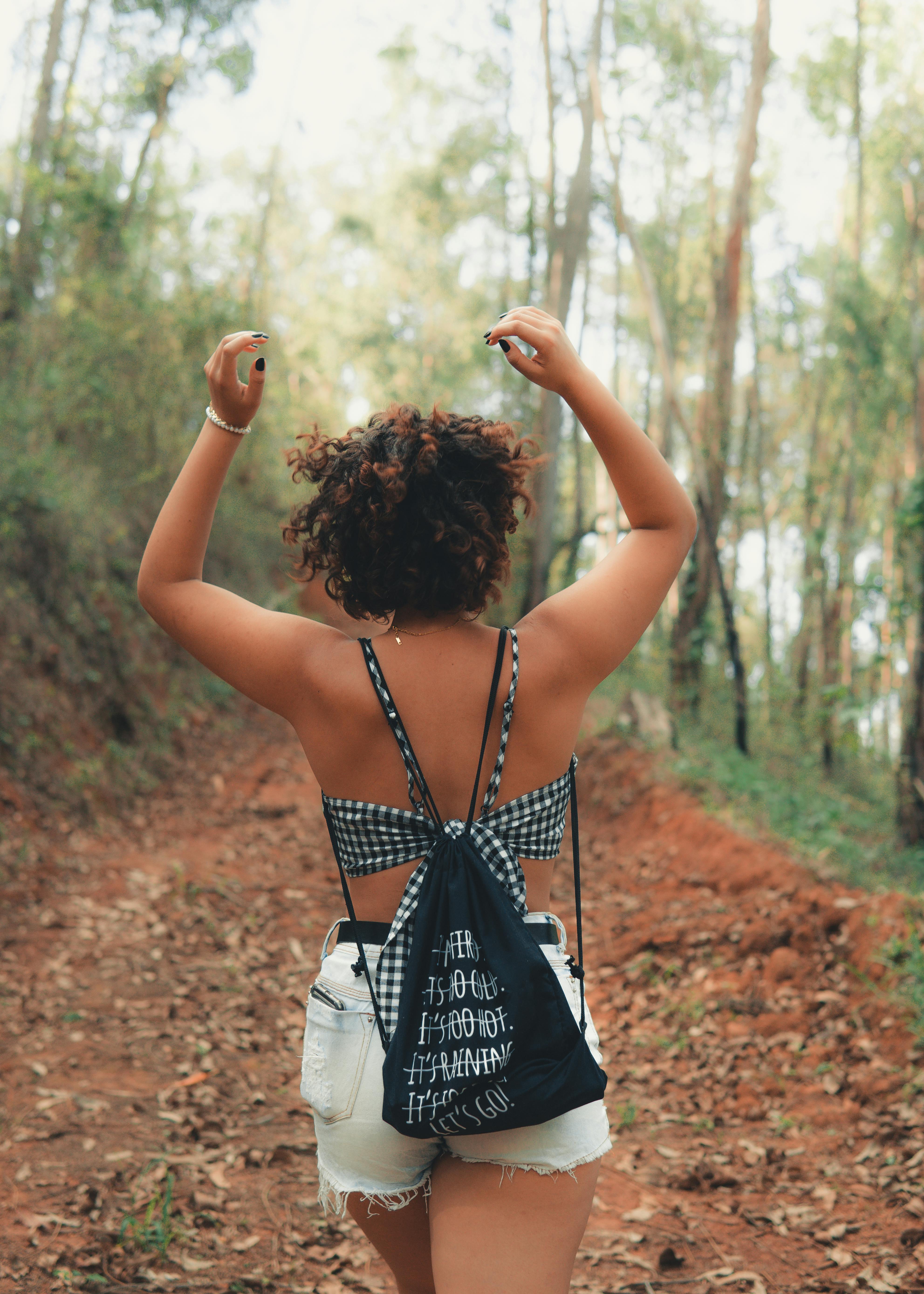 Back View of a Woman with Her Arms Raised · Free Stock Photo
