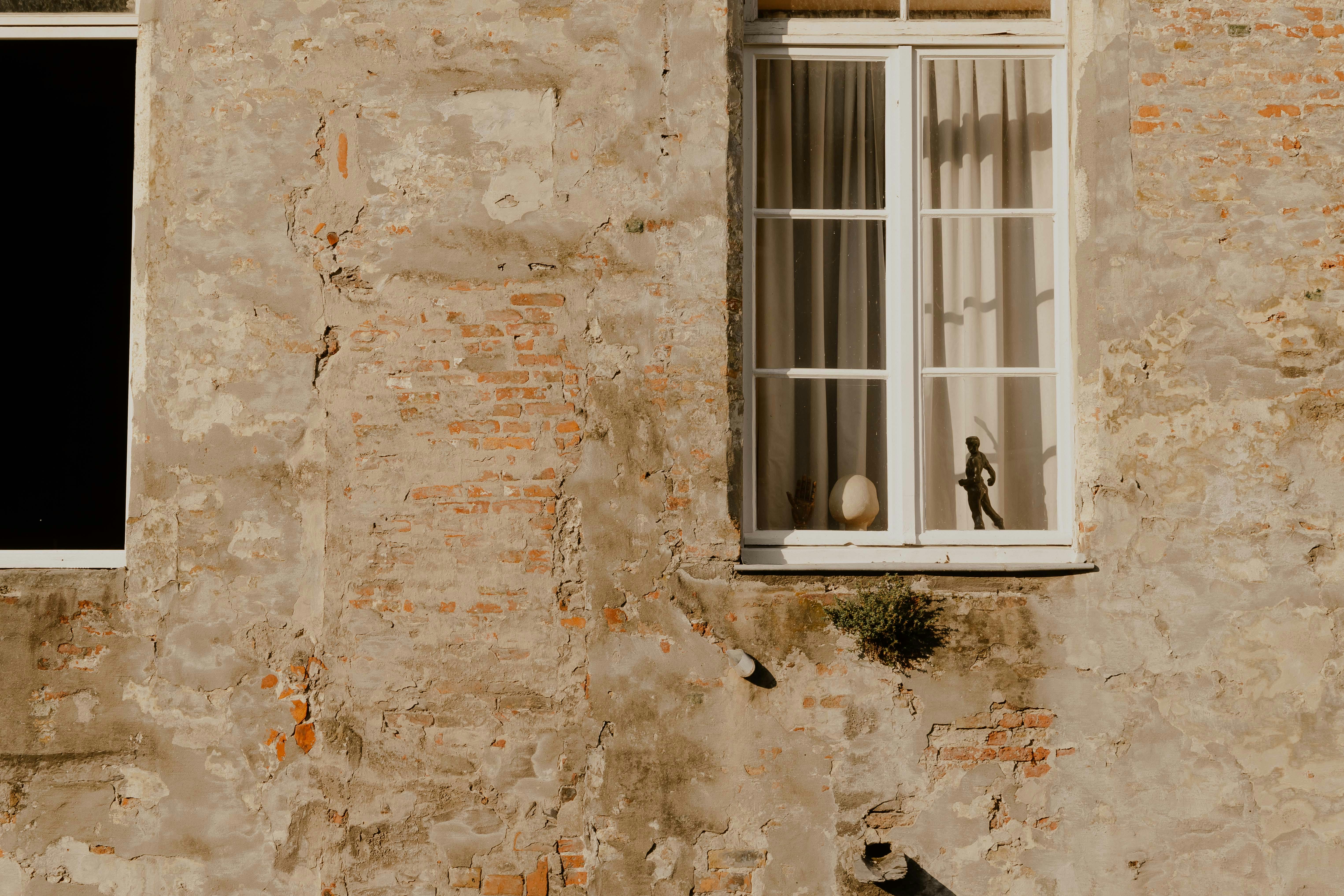 A White Window Frame with Glass on a Concrete Wall · Free Stock Photo