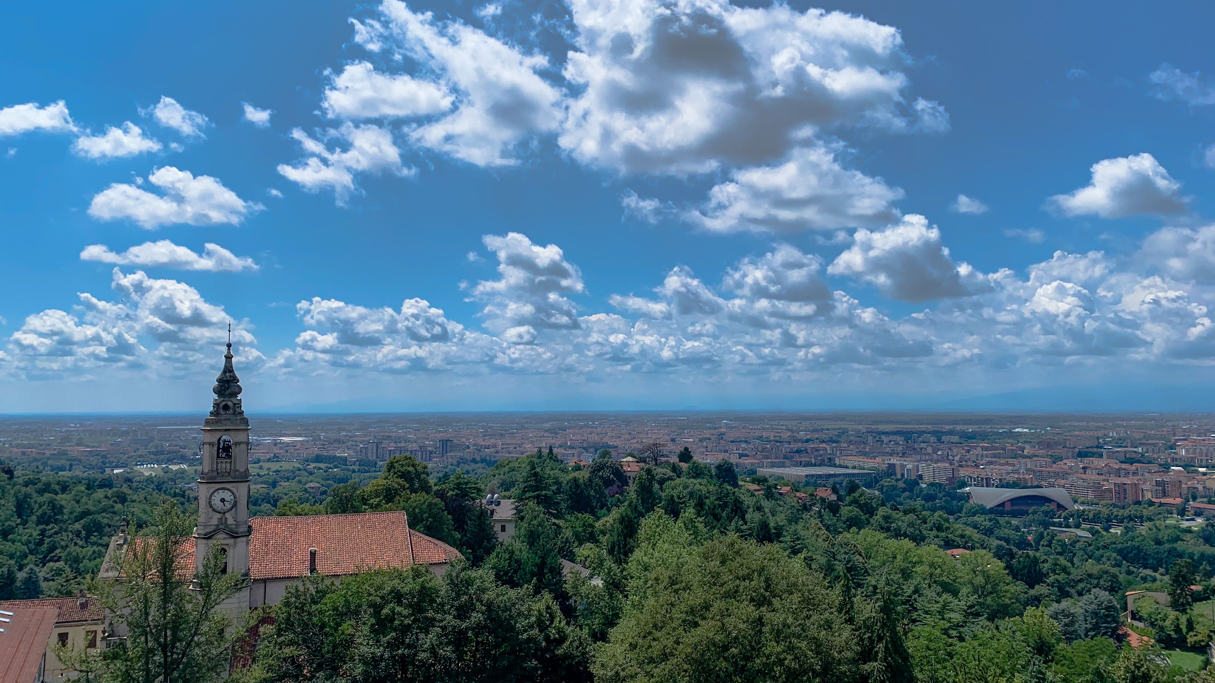 Aerial View of Church Building and Tower Under Blue Sky with White ...