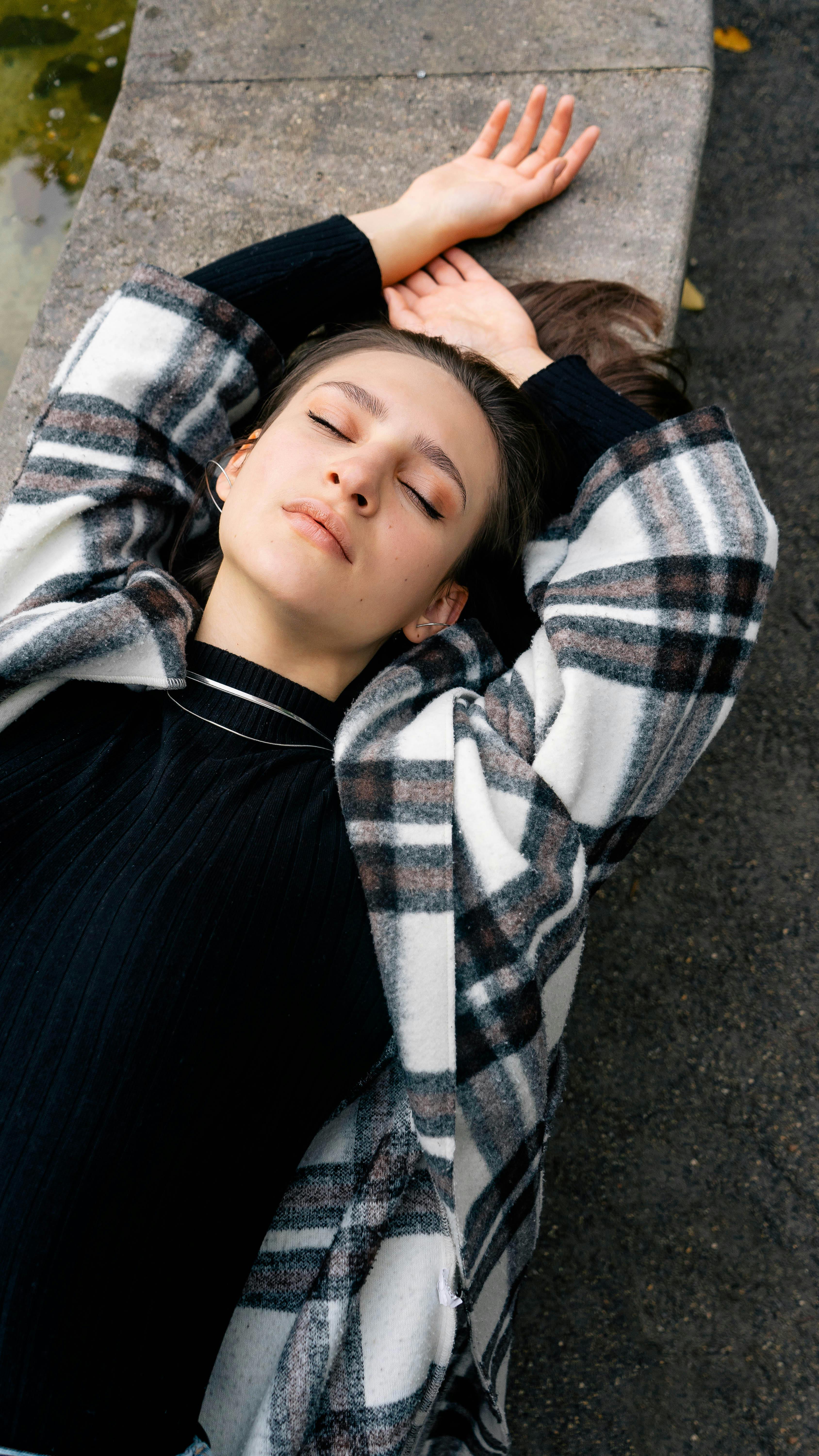 A Woman in a Brown Jacket Lying on Water · Free Stock Photo