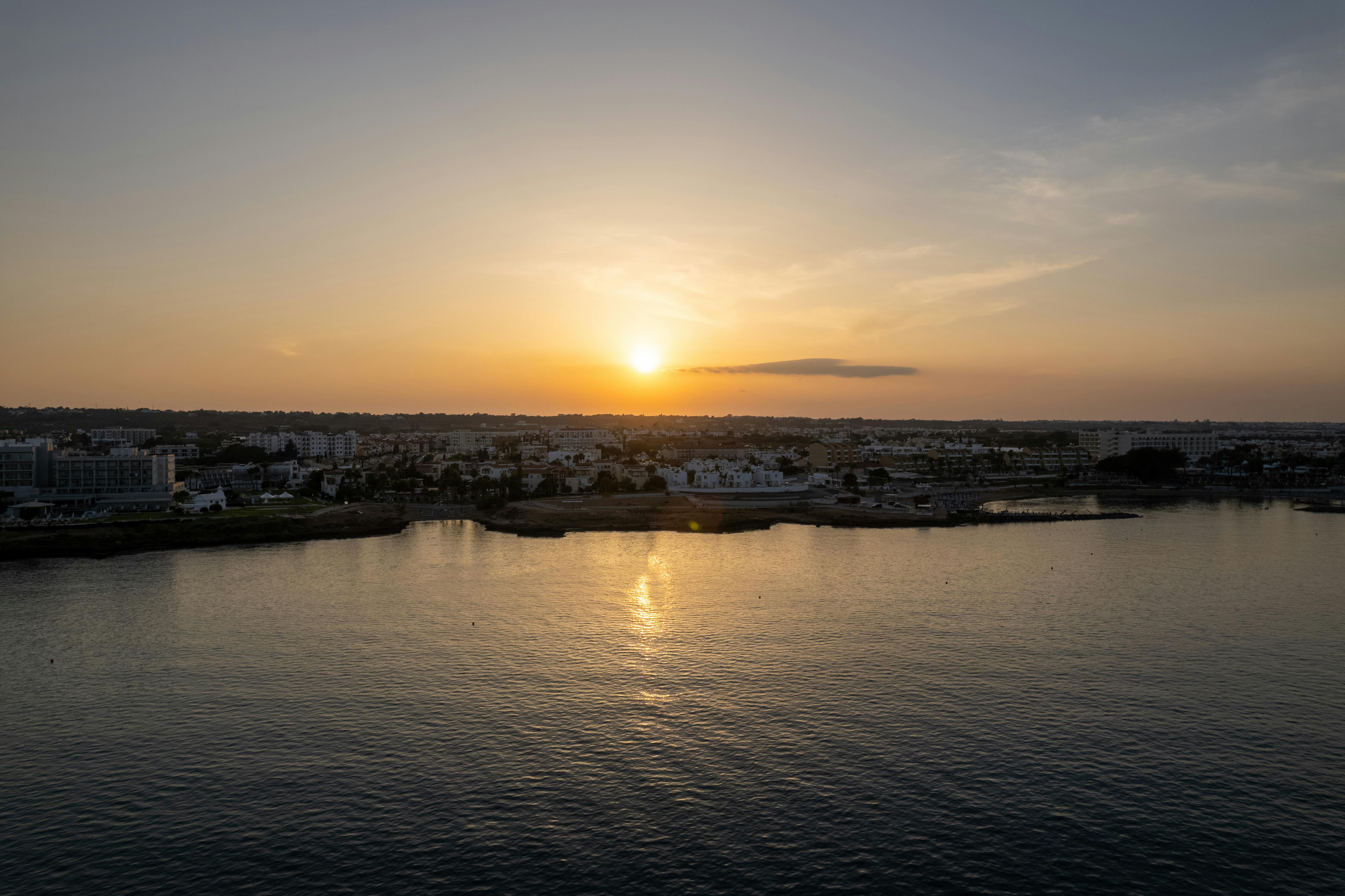 Aerial Photography of City Buildings near Ocean during Sunset · Free ...
