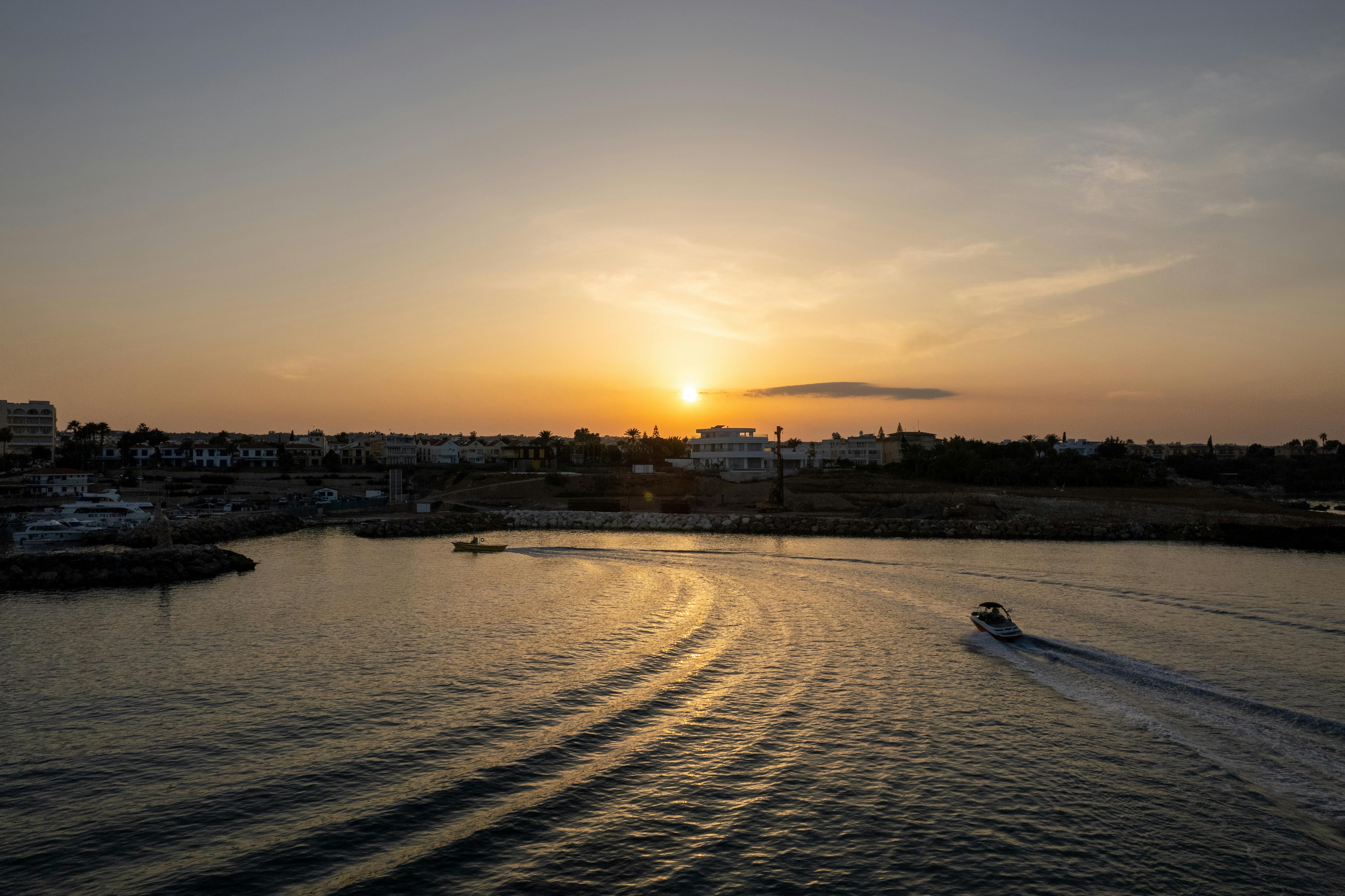 Sunset over Town and Lake with Boats · Free Stock Photo