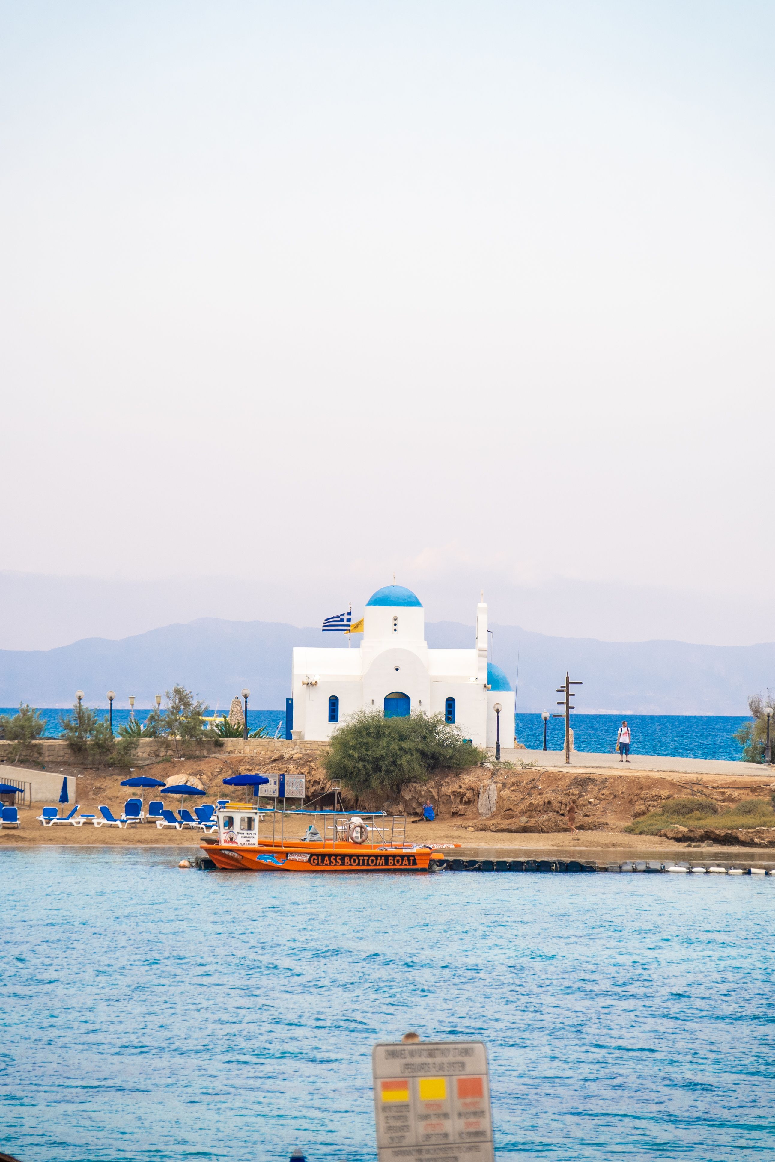 White Church on Beach with Golden Sand and Clear Blue Waters · Free ...