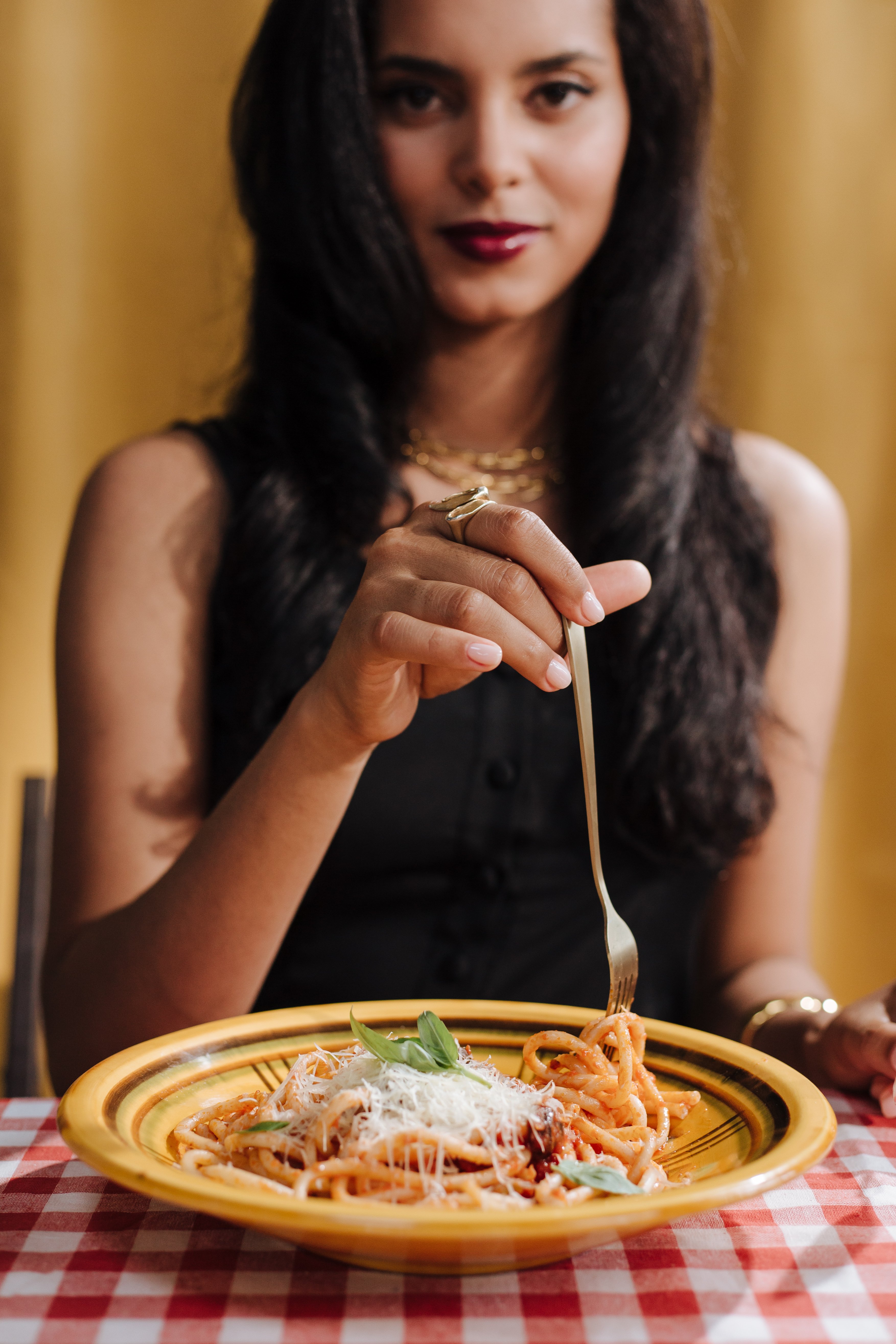 A Profile View of a Female Eating a Pasta · Free Stock Photo