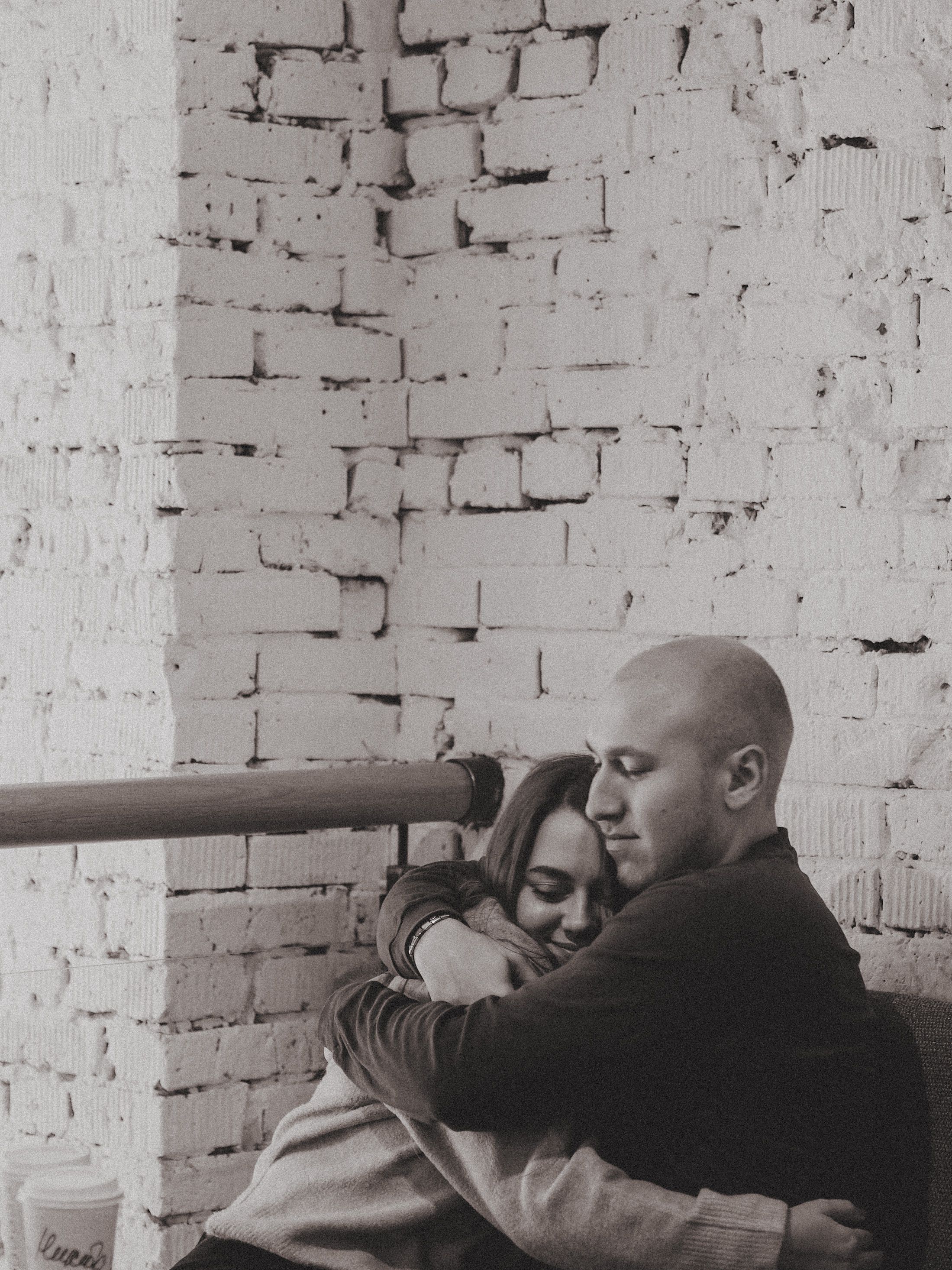 Grayscale Photo of Man Hugging Woman · Free Stock Photo