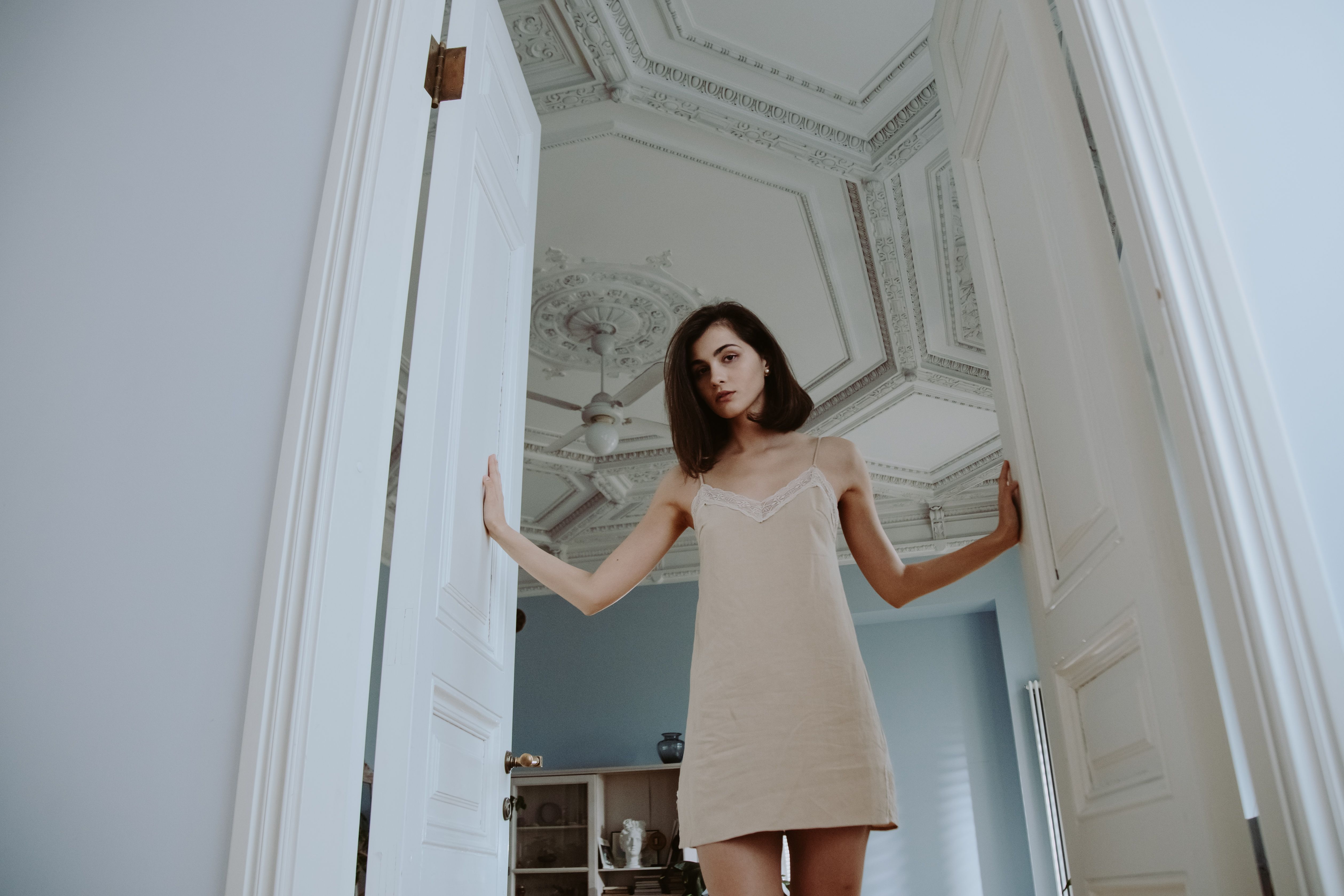 Woman Standing at the Doorway · Free Stock Photo