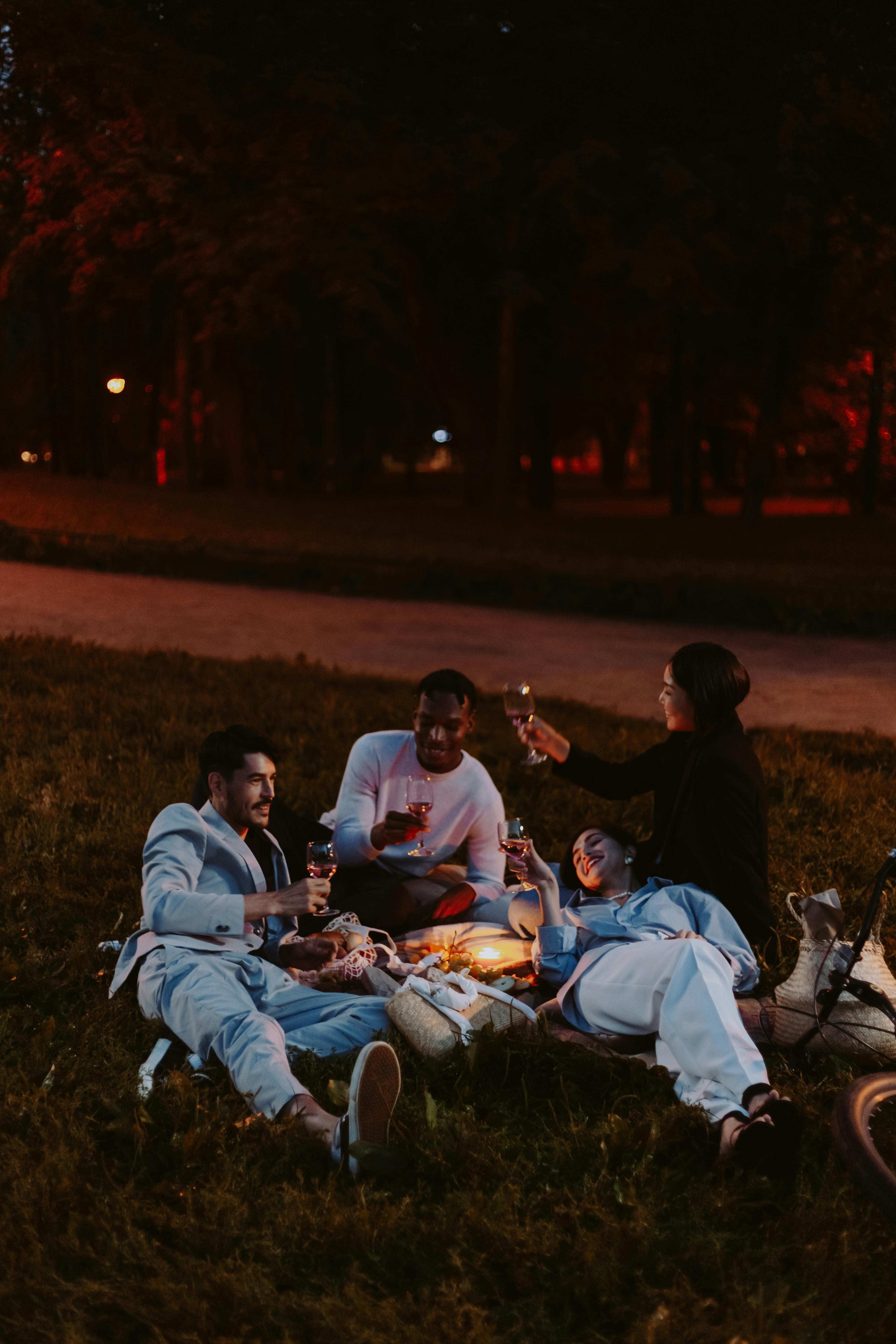 Friends on a Picnic in Park at Night · Free Stock Photo