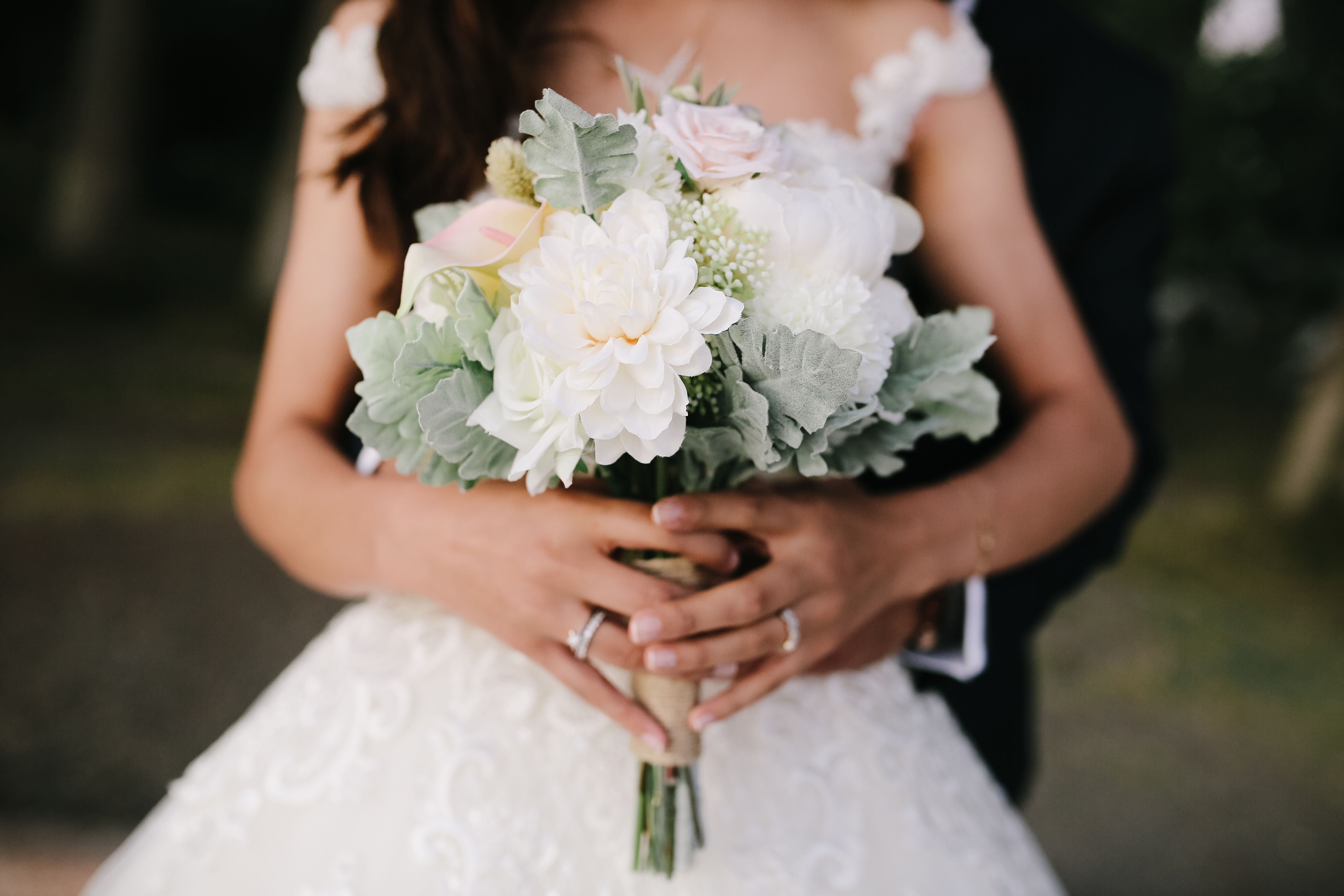 A Bride Holding a Bouquet of Flowers · Free Stock Photo