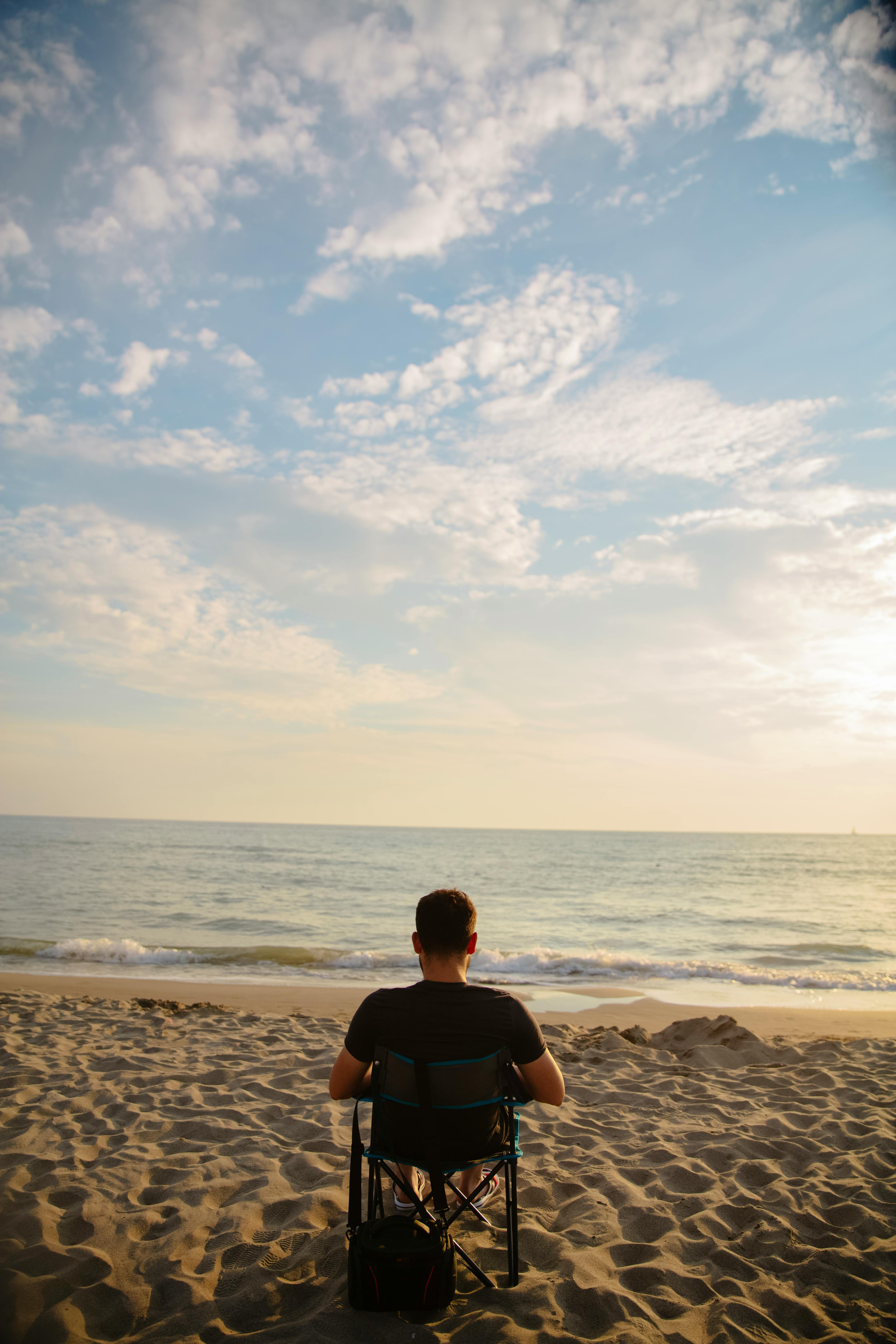 A Man Sitting at the Beach · Free Stock Photo