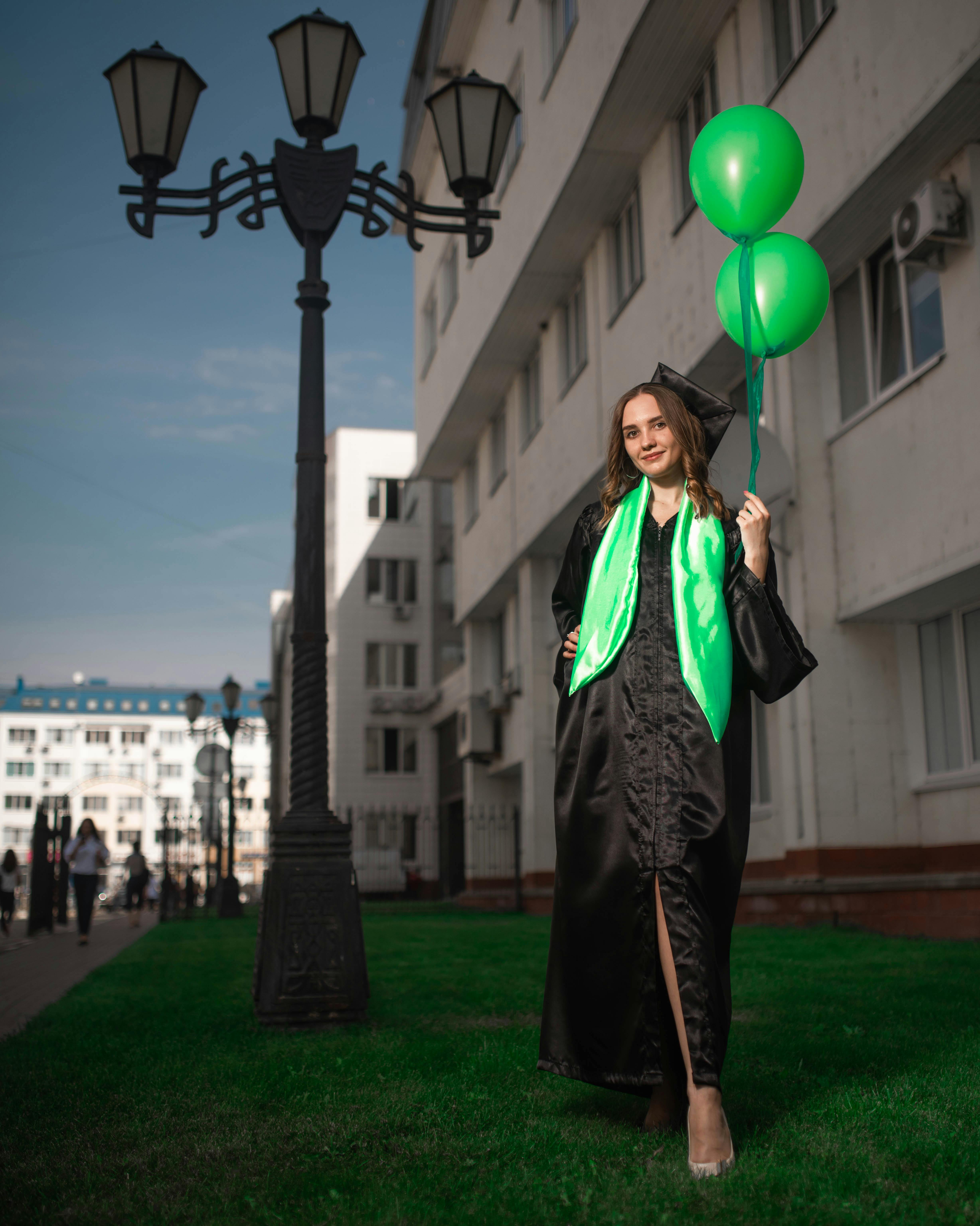 A Back View of a Man in Black Academic Regalia Raising Hand while ...