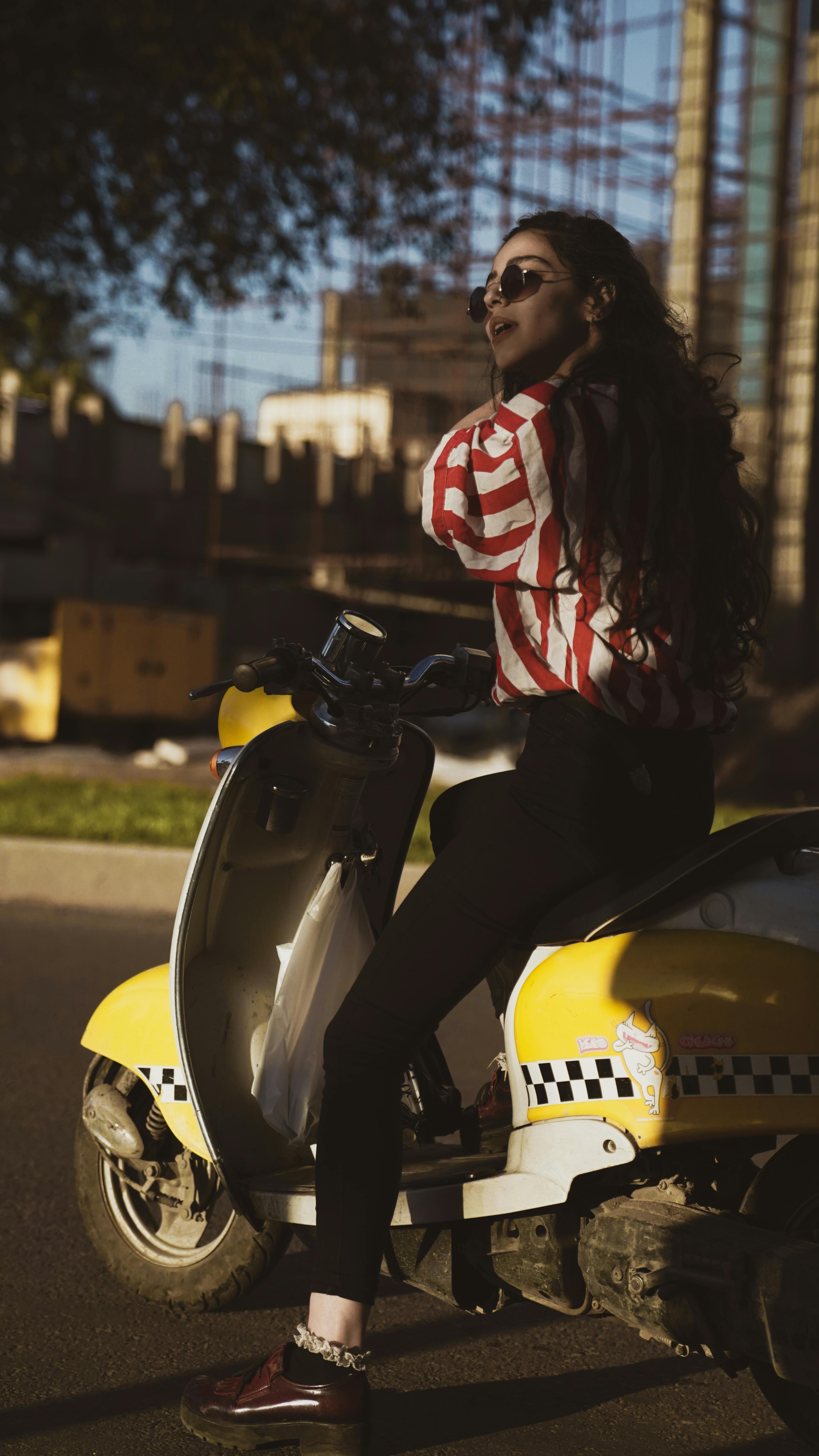 Two People riding a Scooter on a City Road · Free Stock Photo