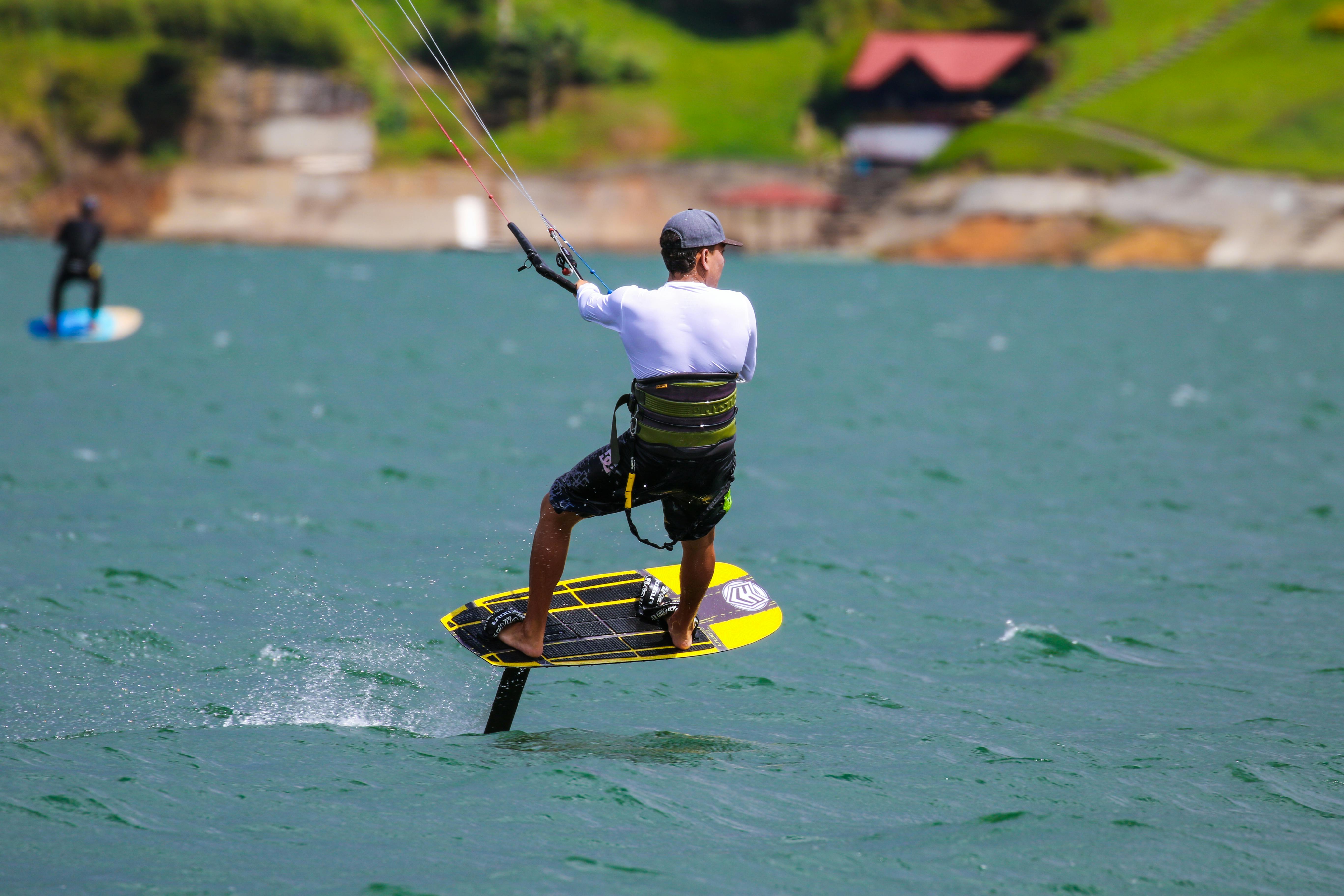 Man Laying Down on a Wakeboard on a Lake · Free Stock Photo