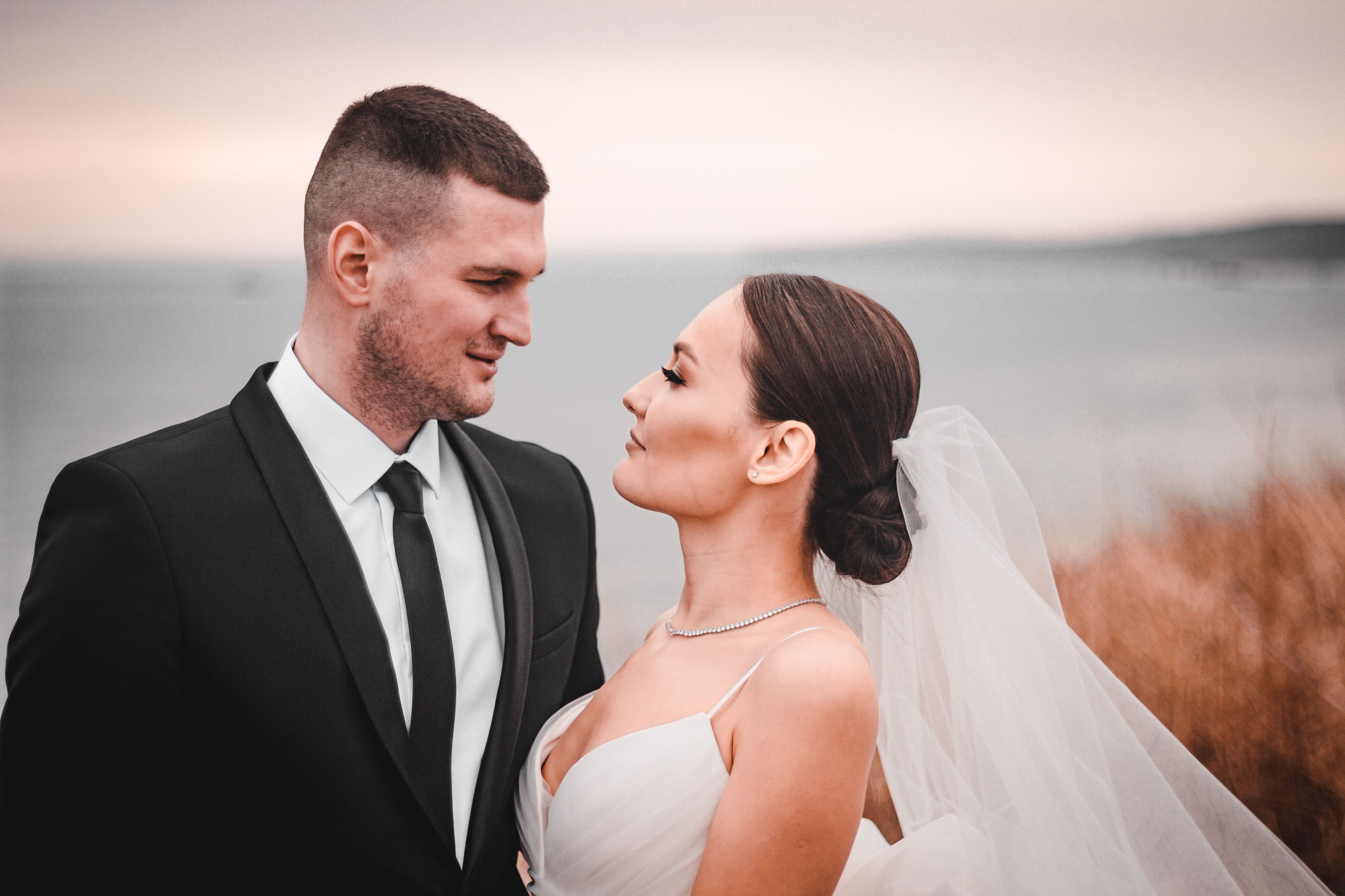 A Groom Hugging is Bride From Behind · Free Stock Photo