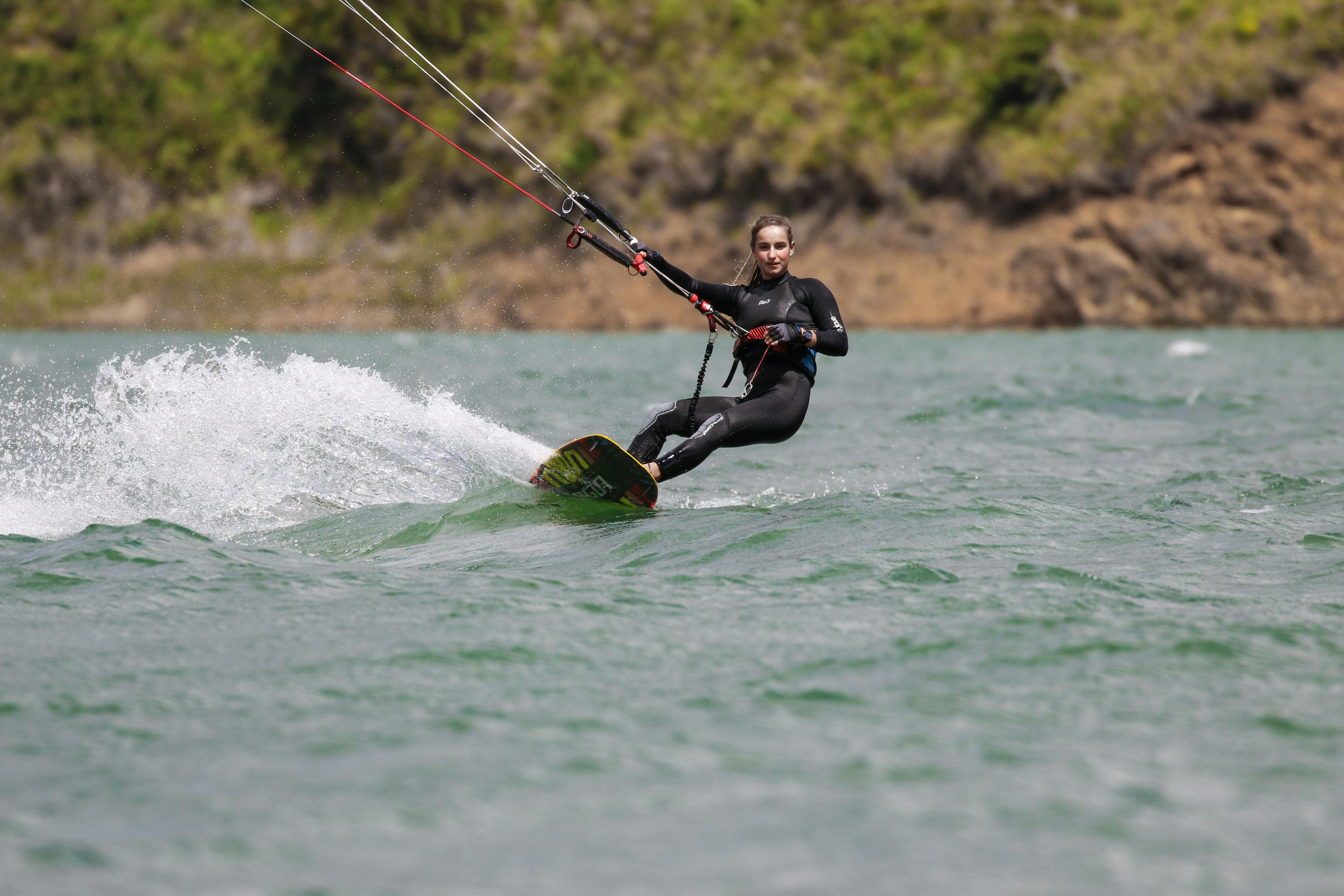 Woman in Black Wetsuit Kiteboarding on the Beach · Free Stock Photo