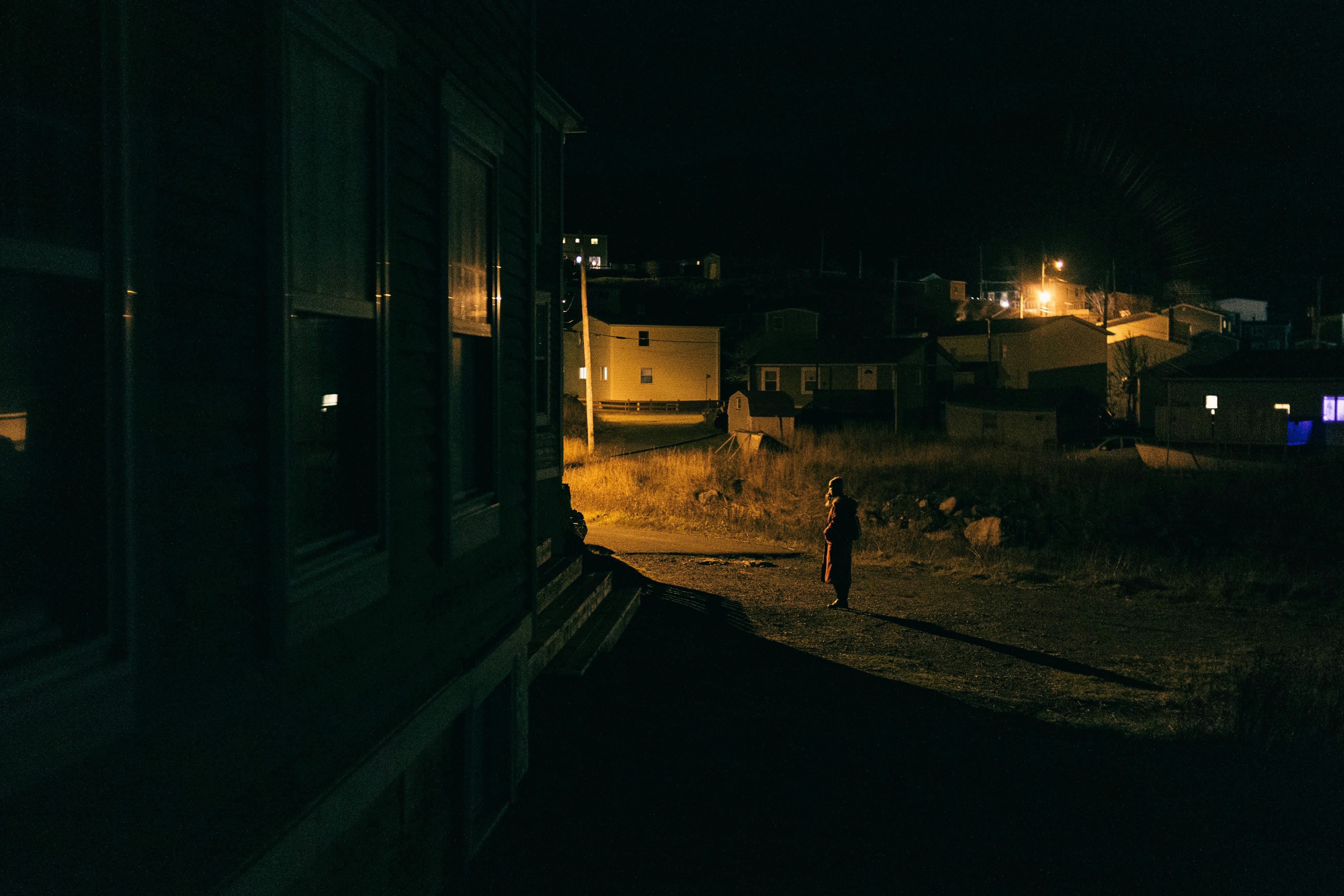 Person standing on a Neighborhood during Nighttime · Free Stock Photo