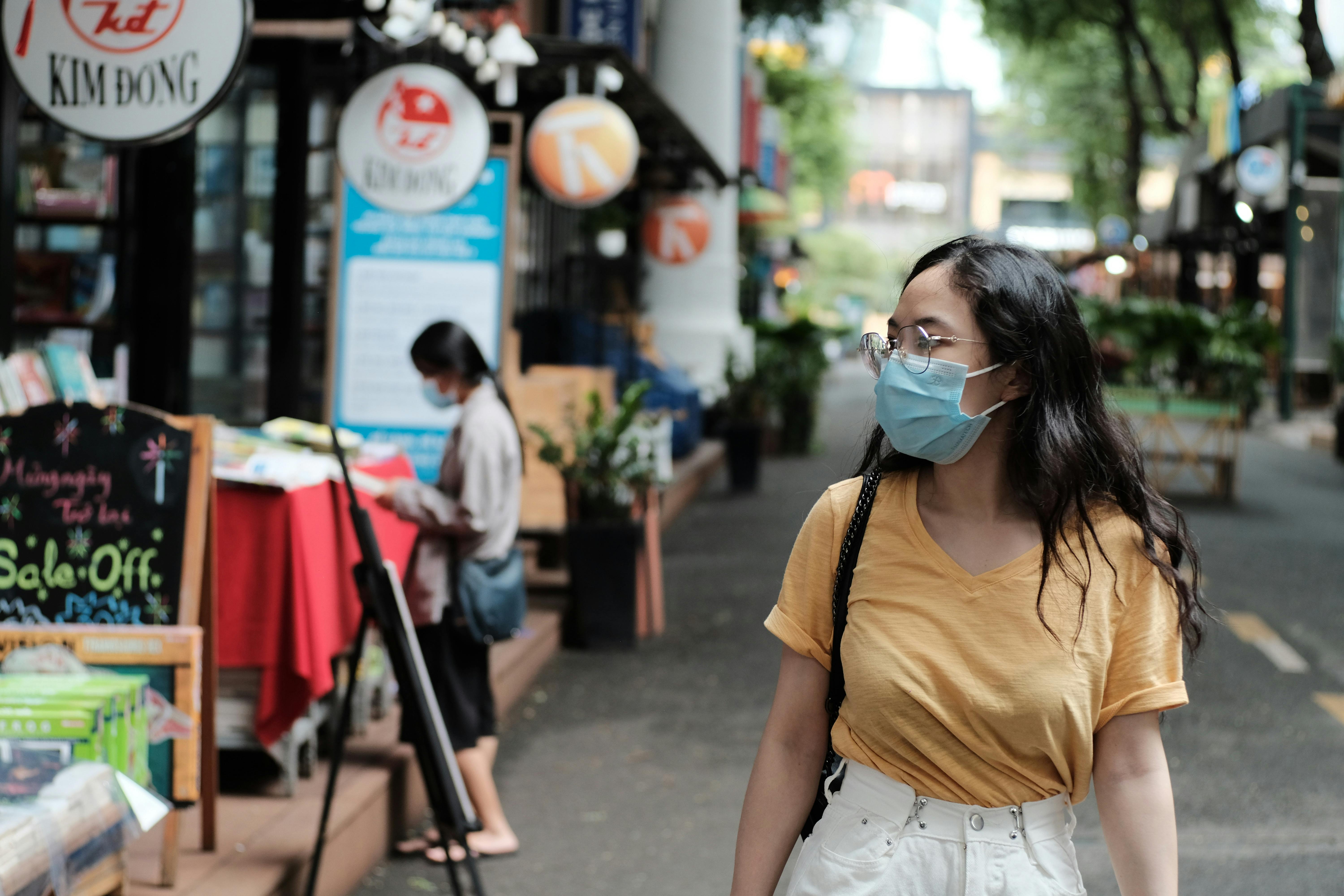 Woman in Yellow Shirt Wearing Face Mask Walking on the Street · Free ...