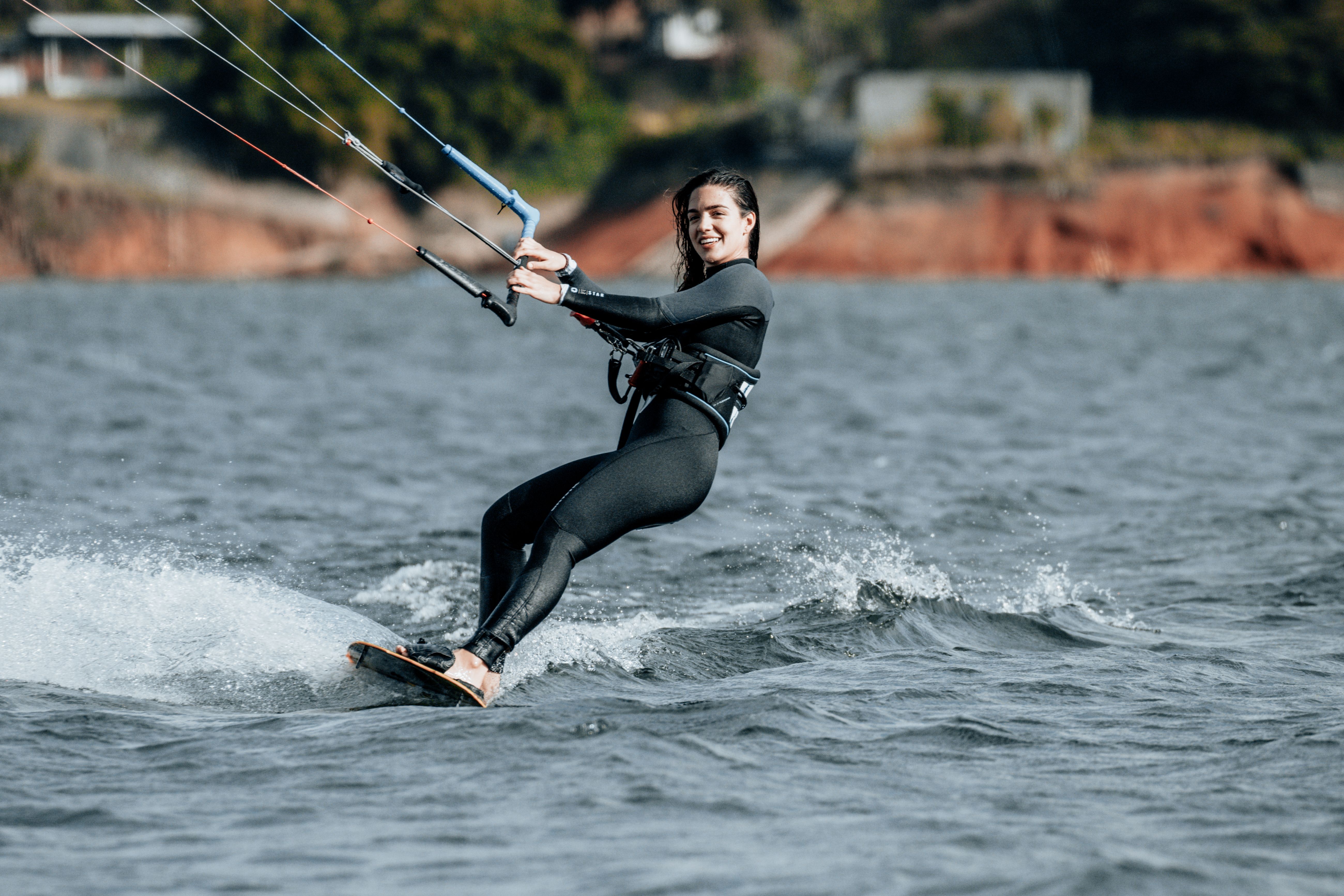 A Beautiful Woman Kitesurfing on the Sea · Free Stock Photo