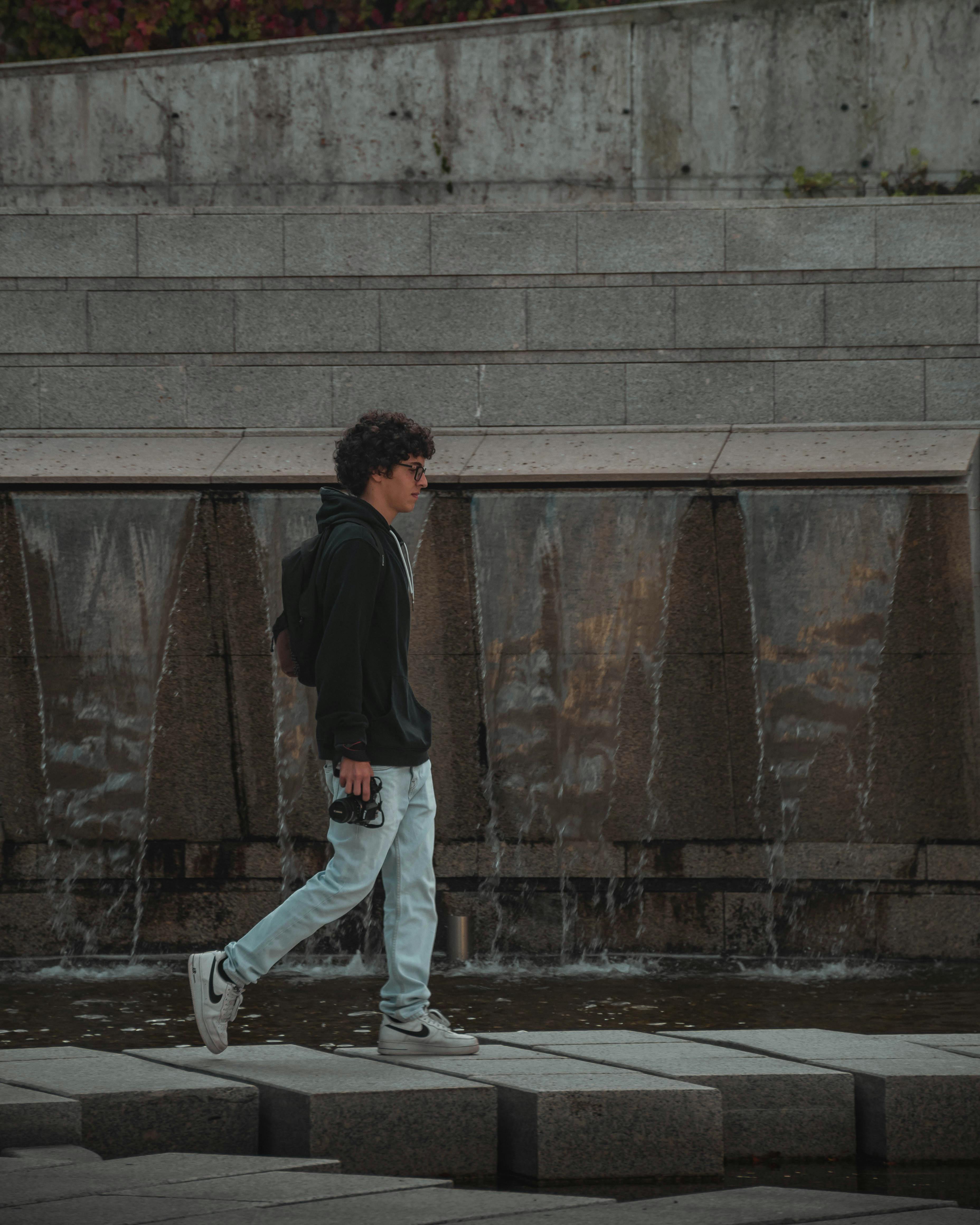 Man Walking While Holding Dslr Camera · Free Stock Photo