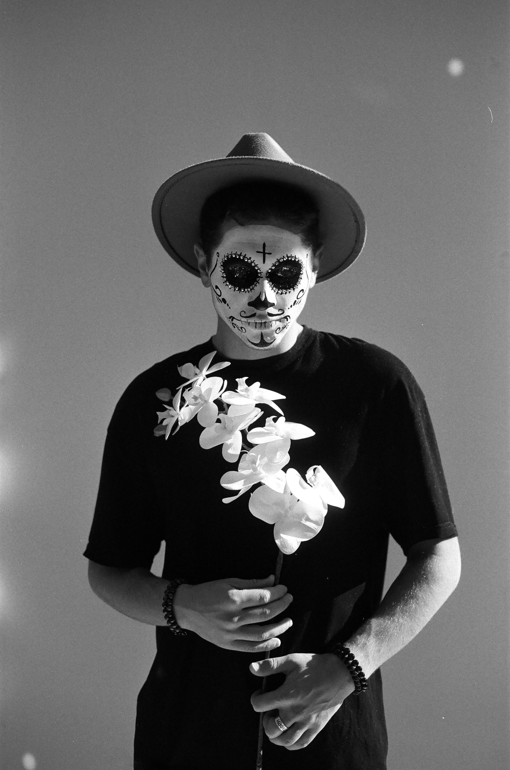 Man in Halloween Mask, Hat and with Flowers · Free Stock Photo