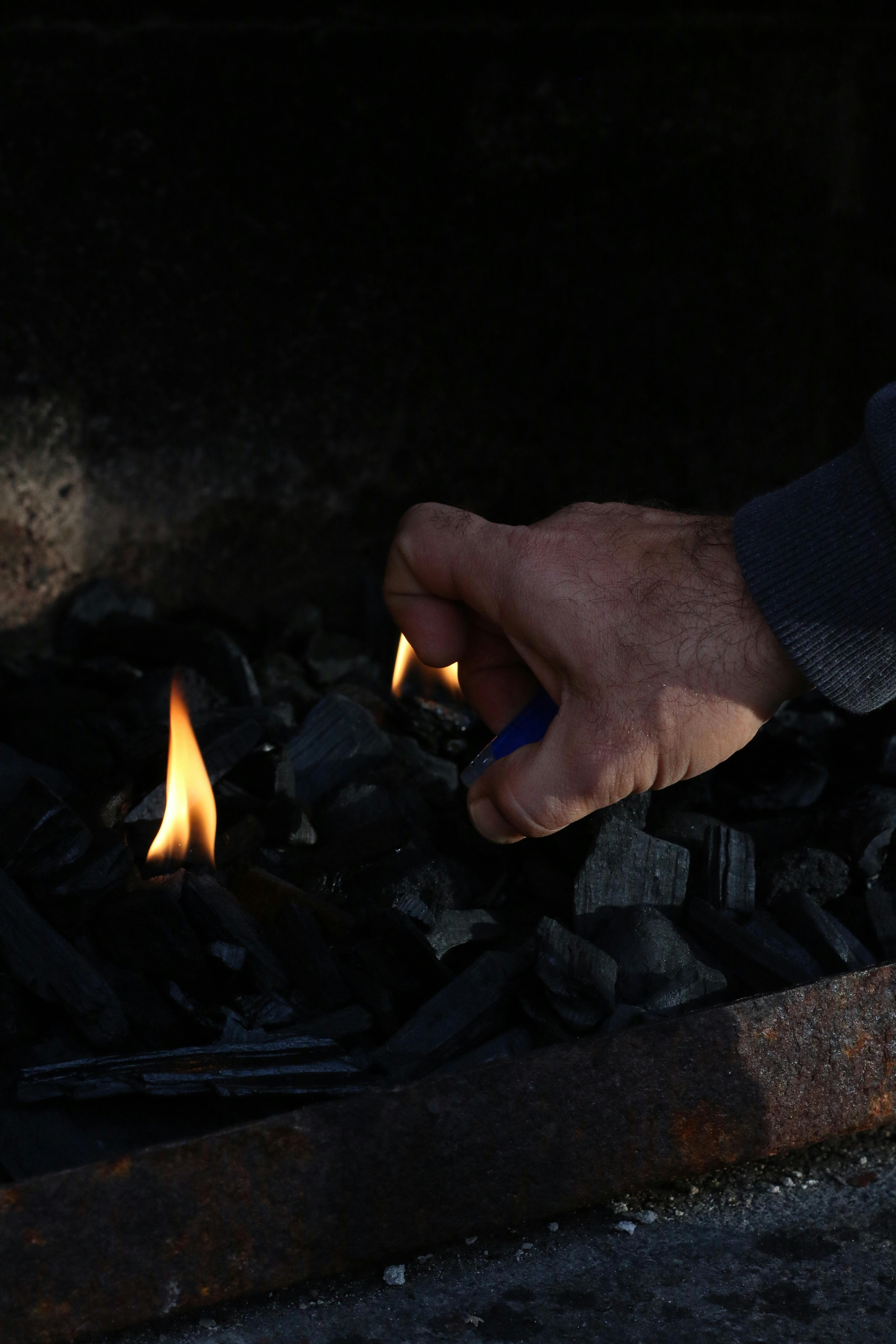 Person Burning Coal · Free Stock Photo